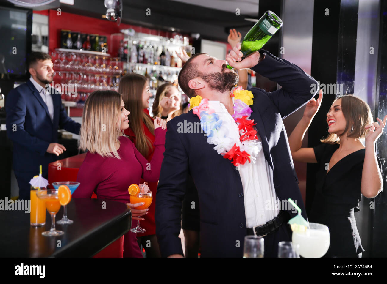 Young man drinking too much on Hawaiian party in bar Stock Photo - Alamy