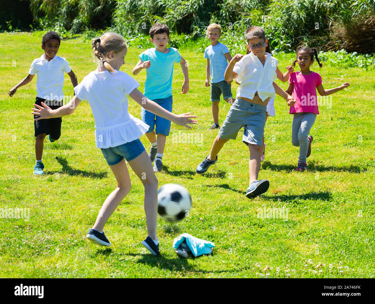 Kids Playing Football In The Park