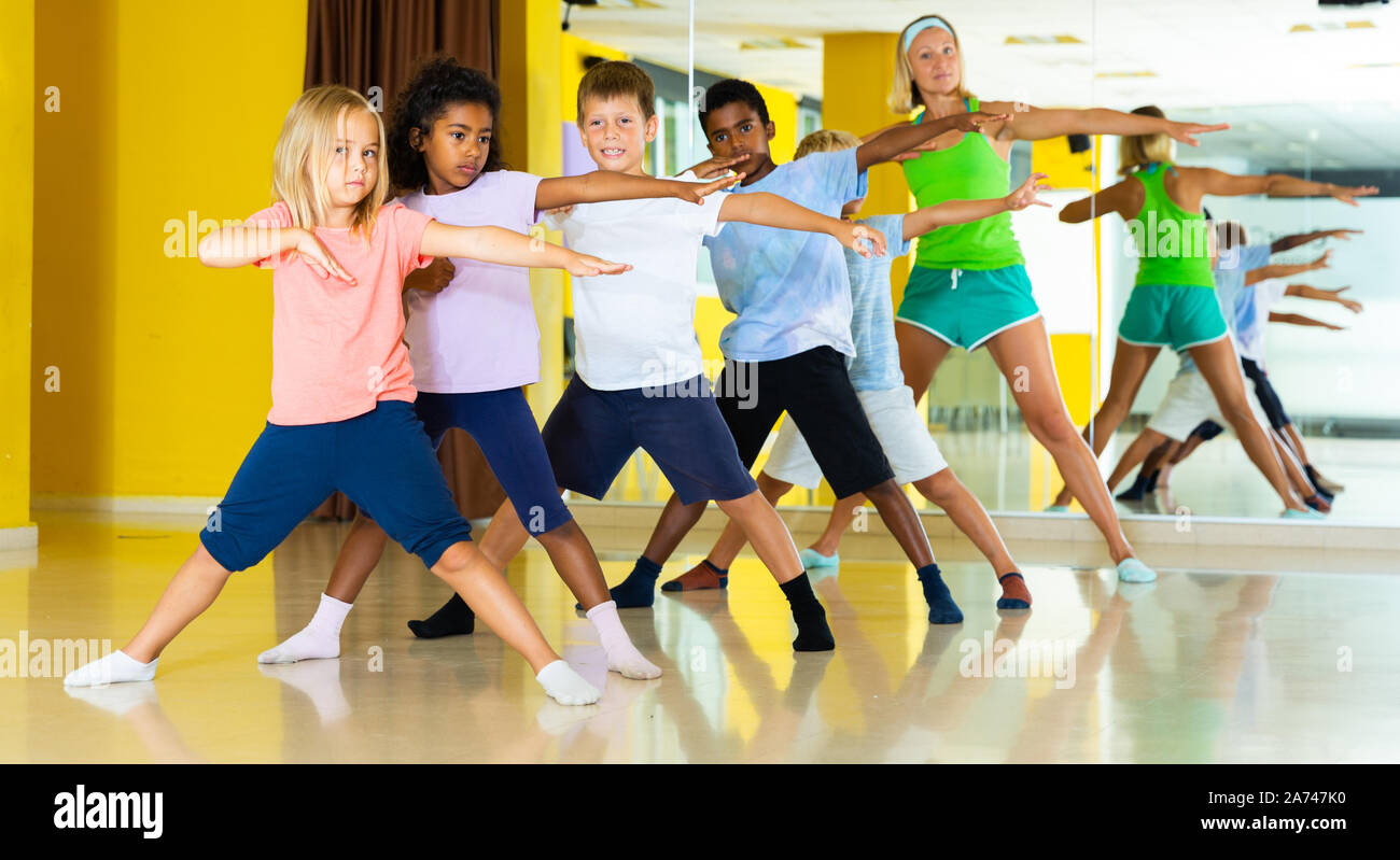 Group of tweens training movements of modern dance in choreography ...