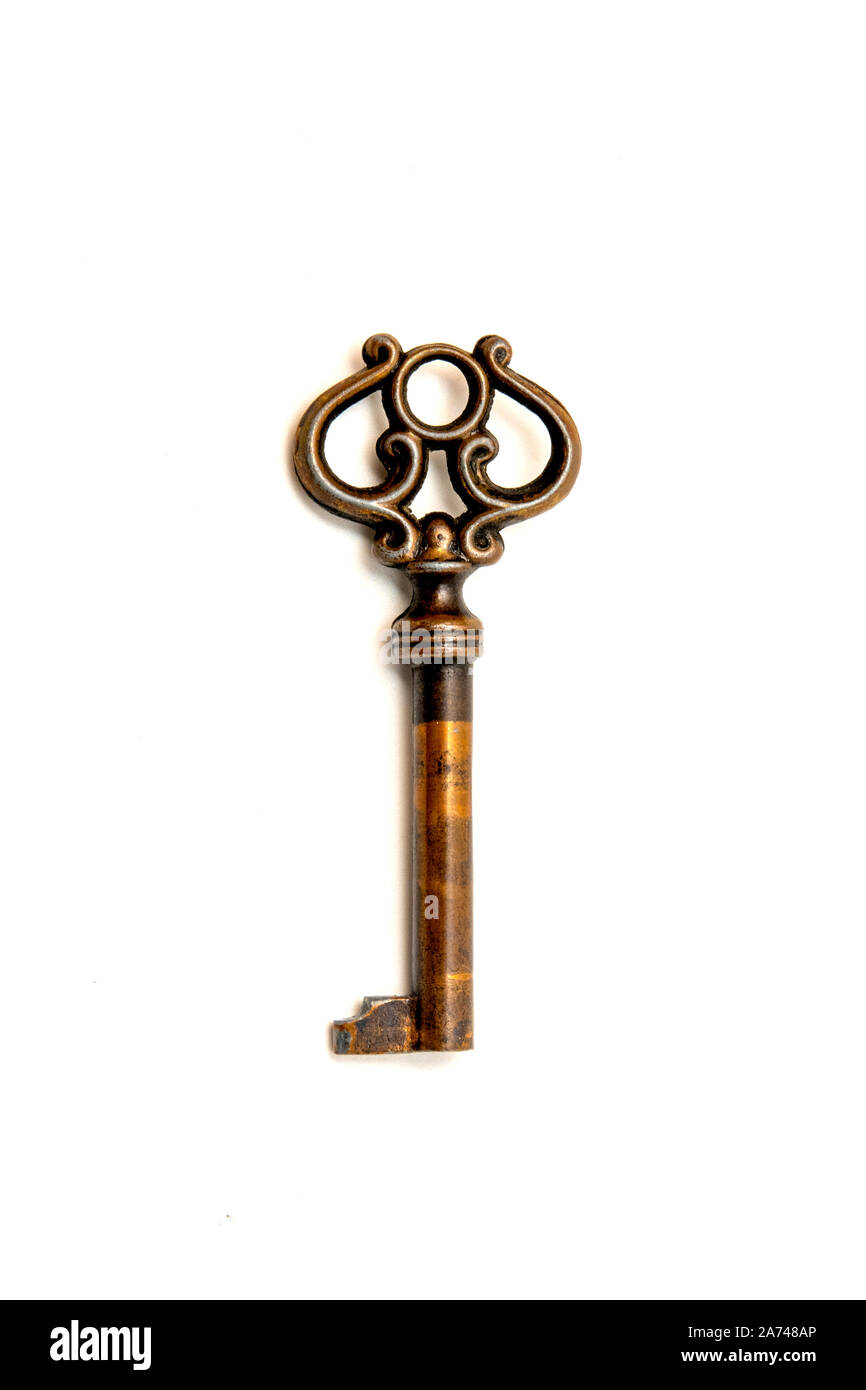 Ornate key on a white background Stock Photo - Alamy