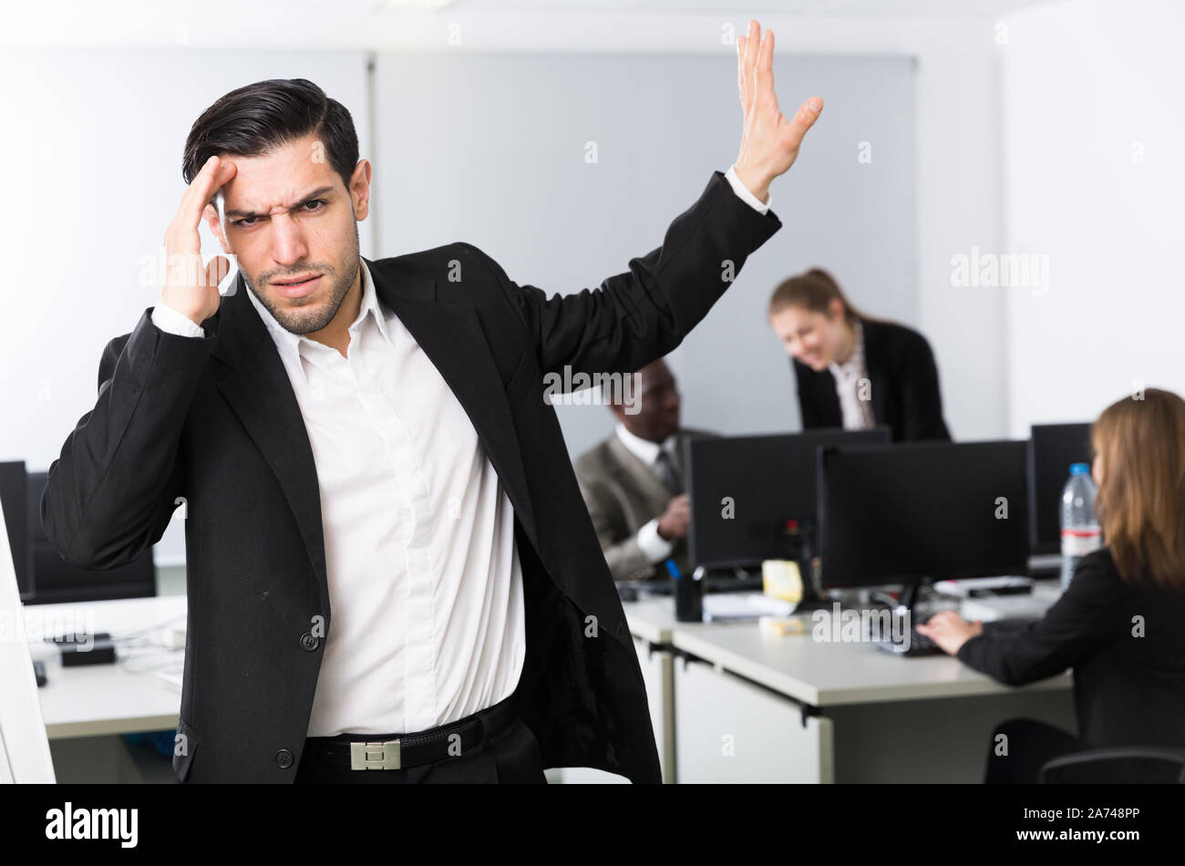 Angry manager standing in office dissatisfied with teamwork of ...