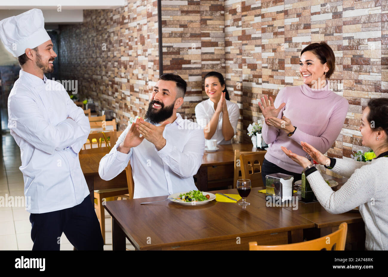 Cheerful positive chef listens to praise of the food Stock Photo - Alamy