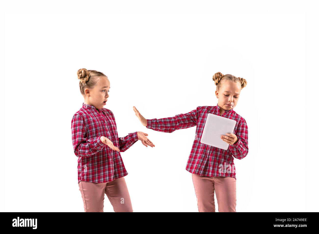 Young handsome girl arguing with herself on white studio background ...