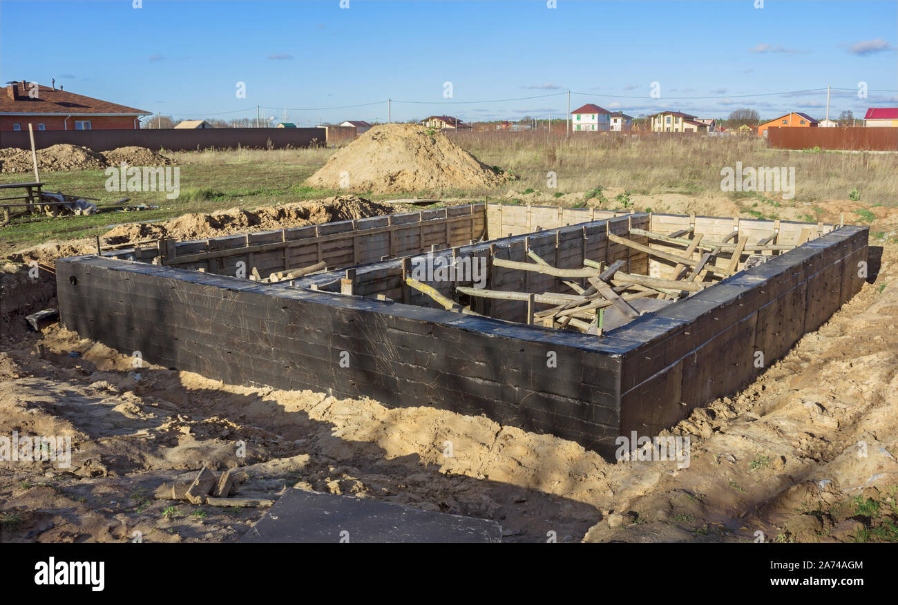 Foundation of future house is filled with concrete. Start of ...