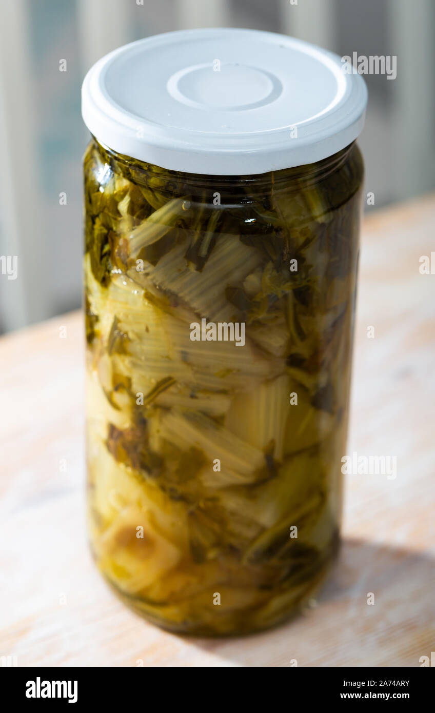 Pickled swiss chard with spices in glass jar on a wooden table Stock ...
