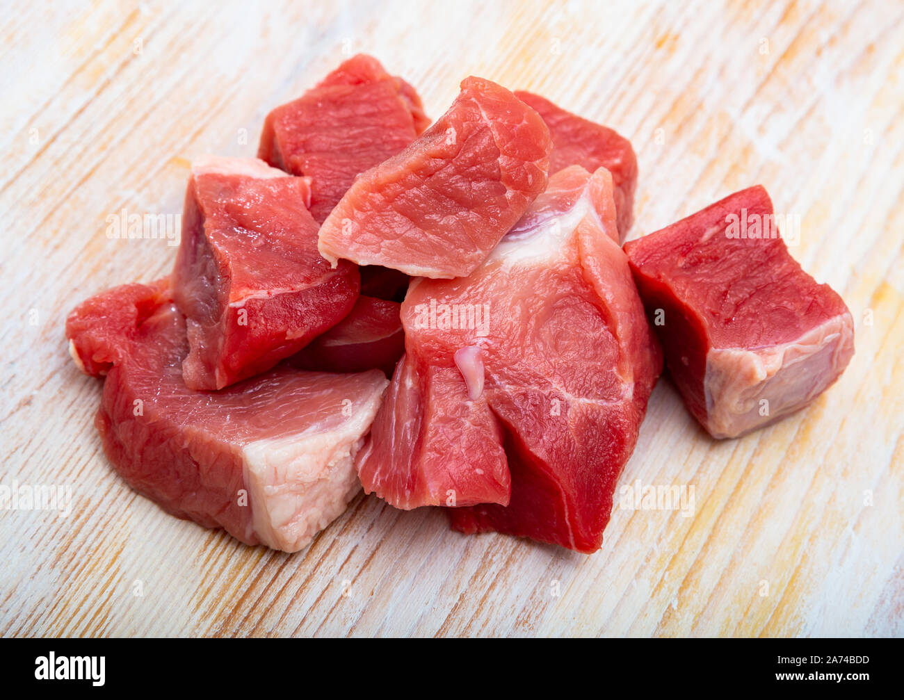 Raw pork neck meat cuts, top view on wooden background fresh slices ...