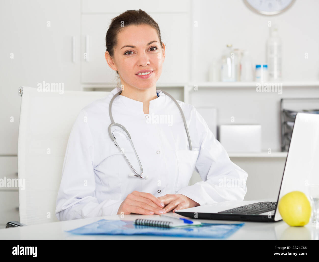 Female doctor having a productive day helping in her office Stock Photo ...