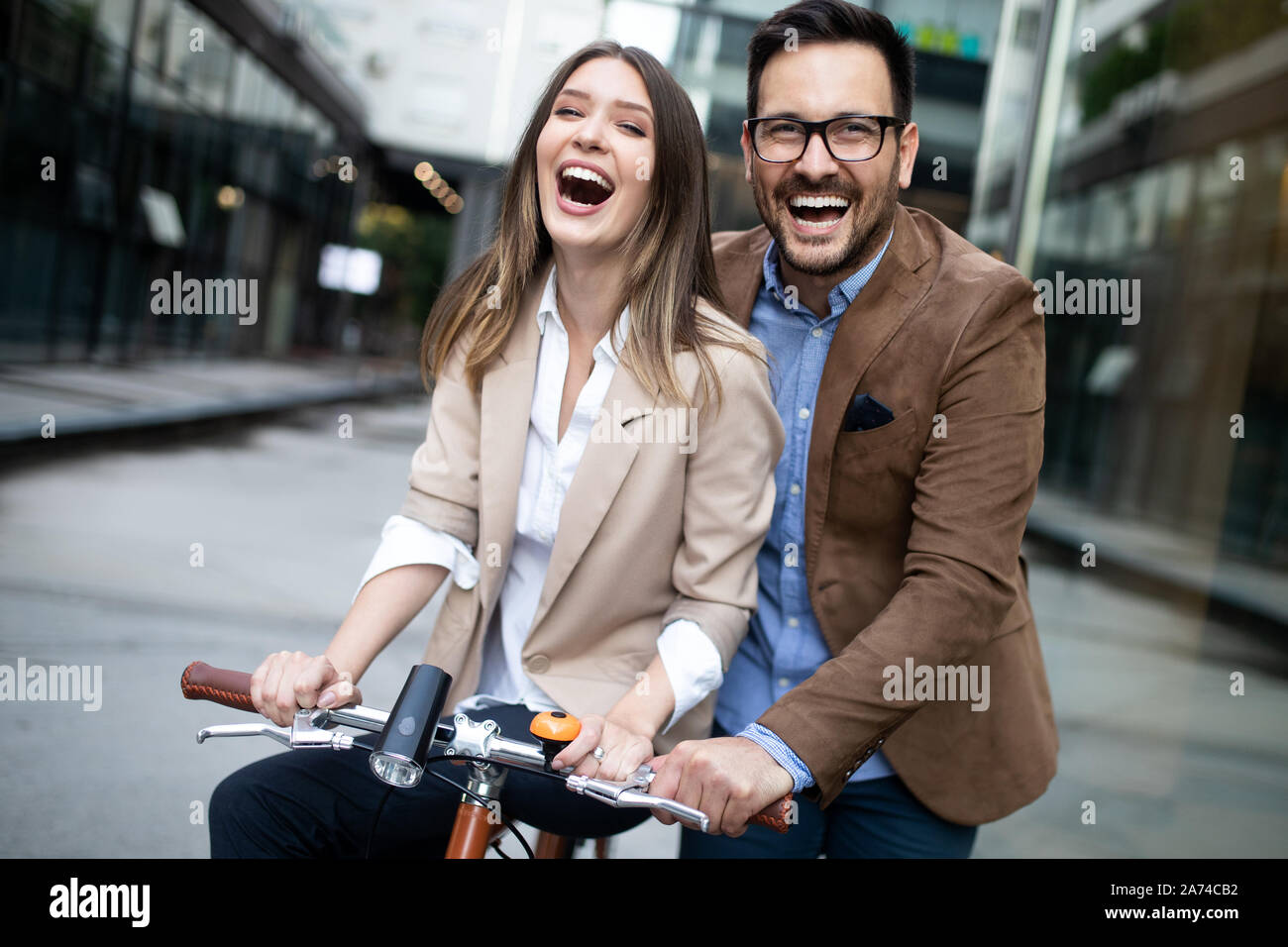 Happy young couple riding on bicycle. Love, relationship, romance ...