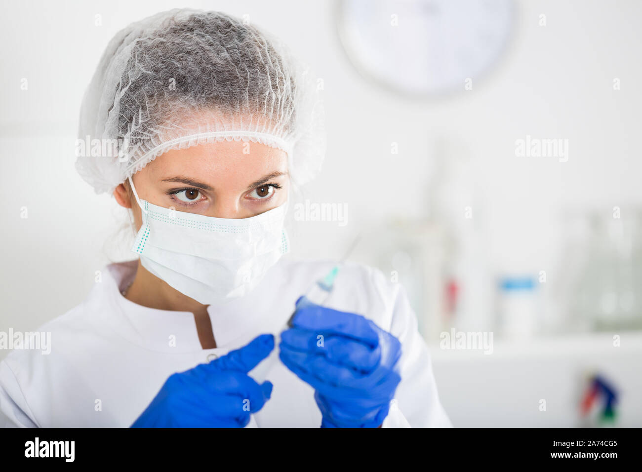 Female nurse holding syringe for injection in hospital Stock Photo - Alamy