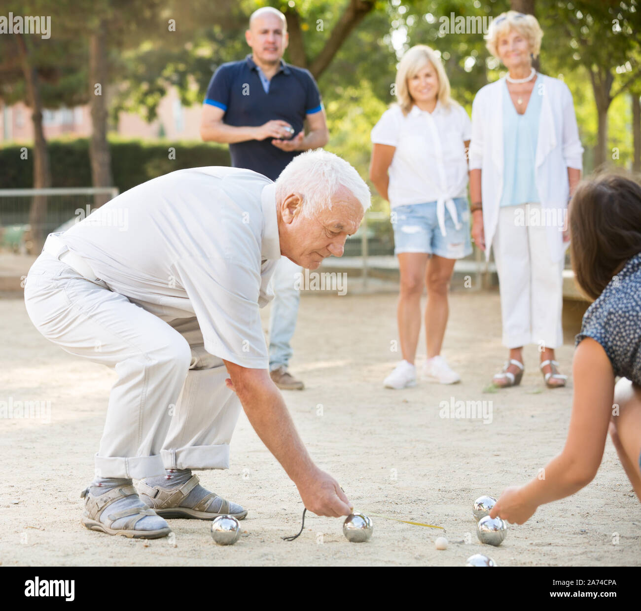 Happy family of two generations playing bocce in garden Stock Photo - Alamy