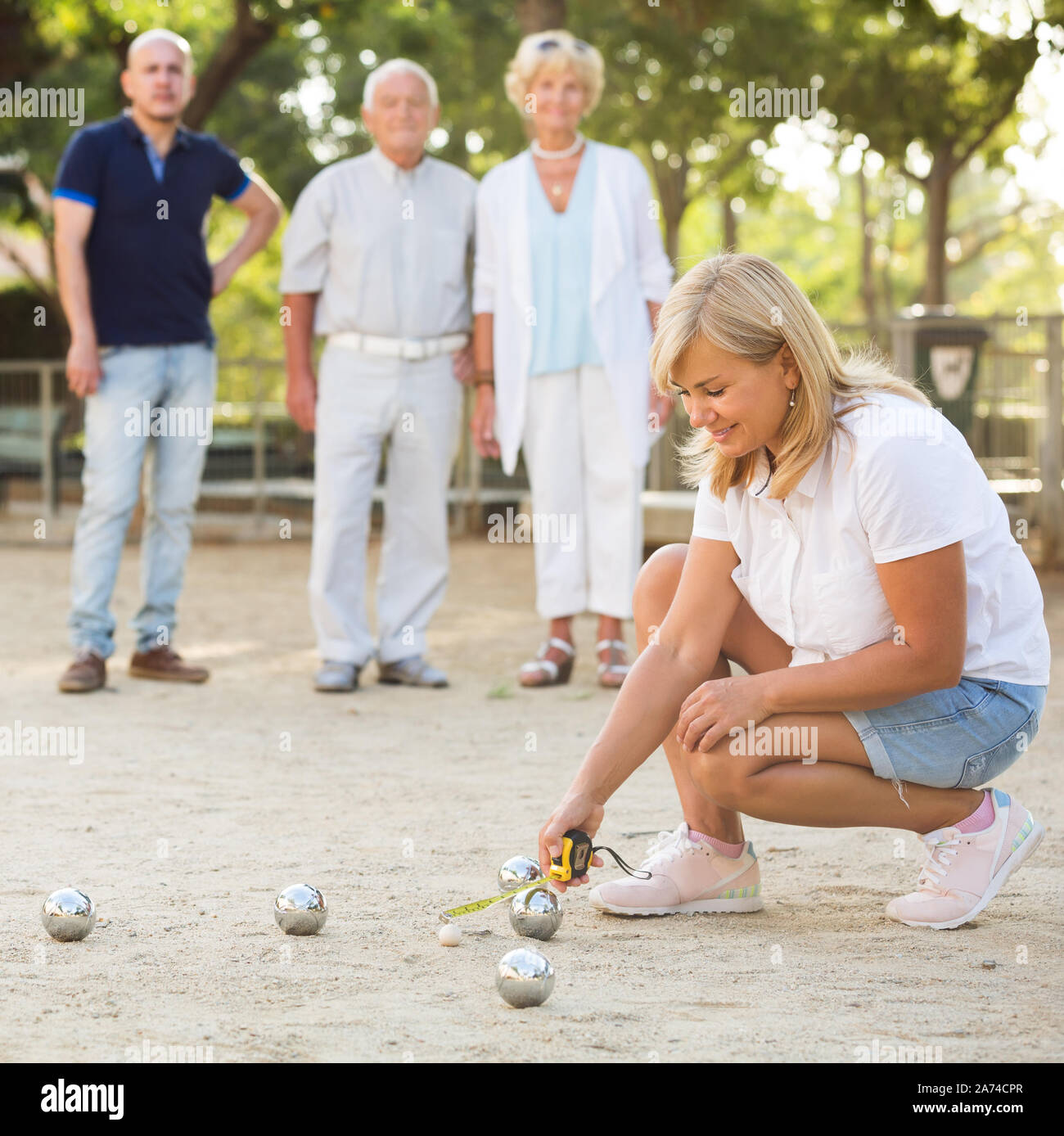 Positive elderly people playing bocce in the garden Stock Photo - Alamy