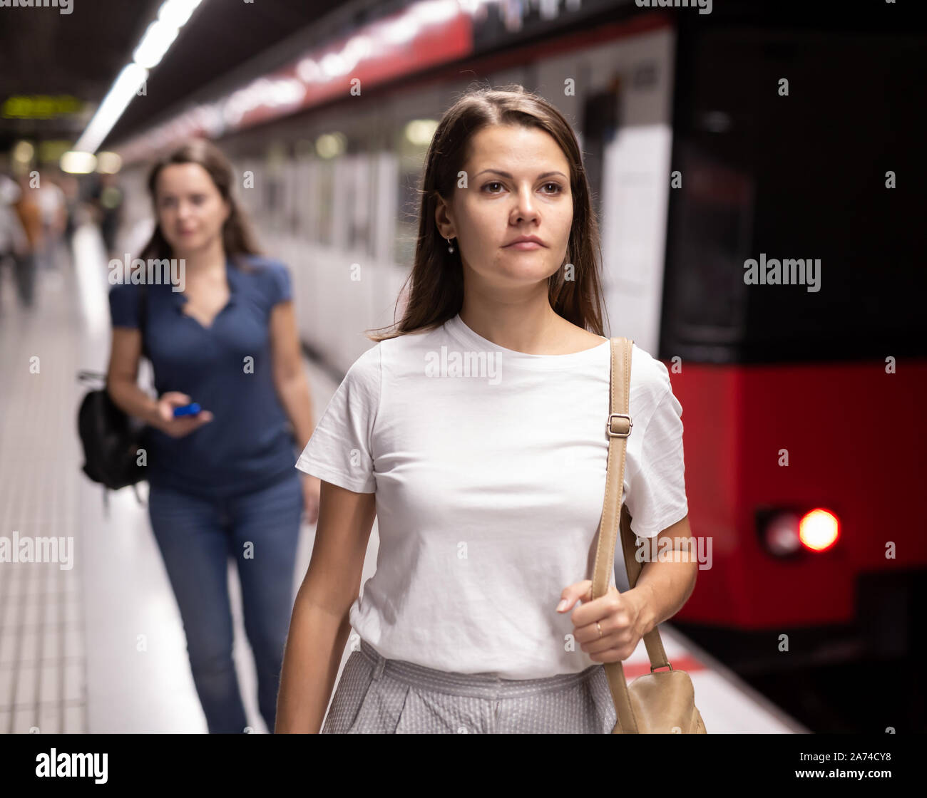 Pretty woman walks on the subway platform Stock Photo - Alamy