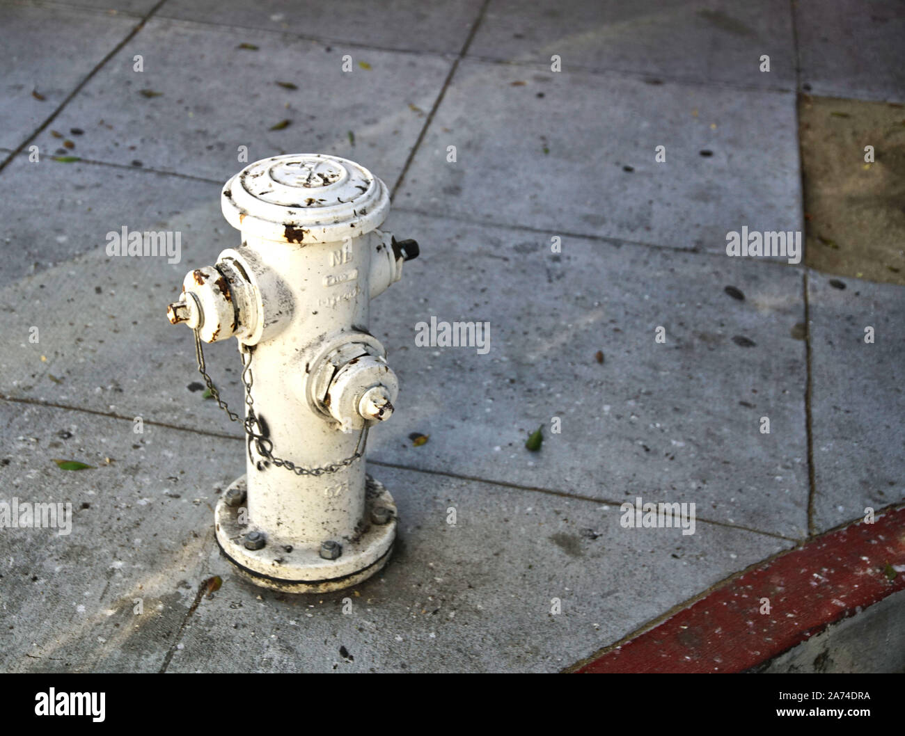 weathered fire hydrant adjacent to the street curb in San Francisco ...