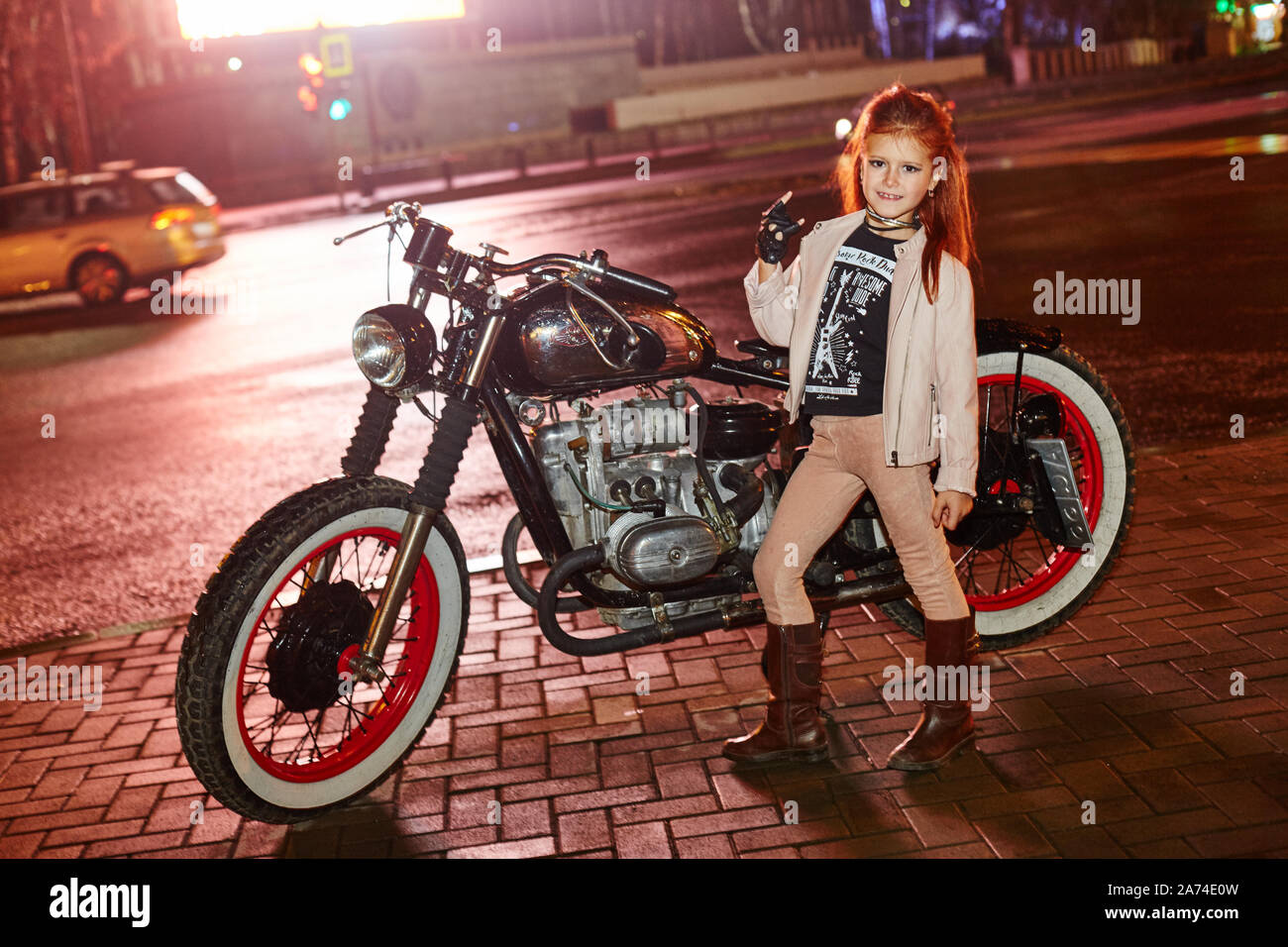 Kids bikers on a motorcycle ride through the city. The young biker ...