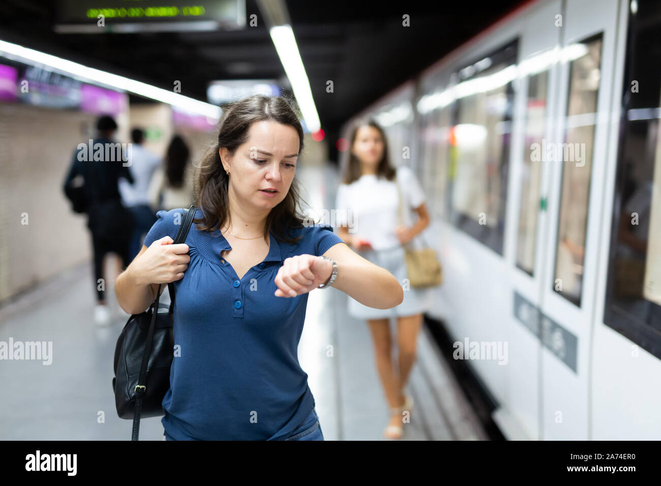 Hurrying woman is late for subway train Stock Photo - Alamy