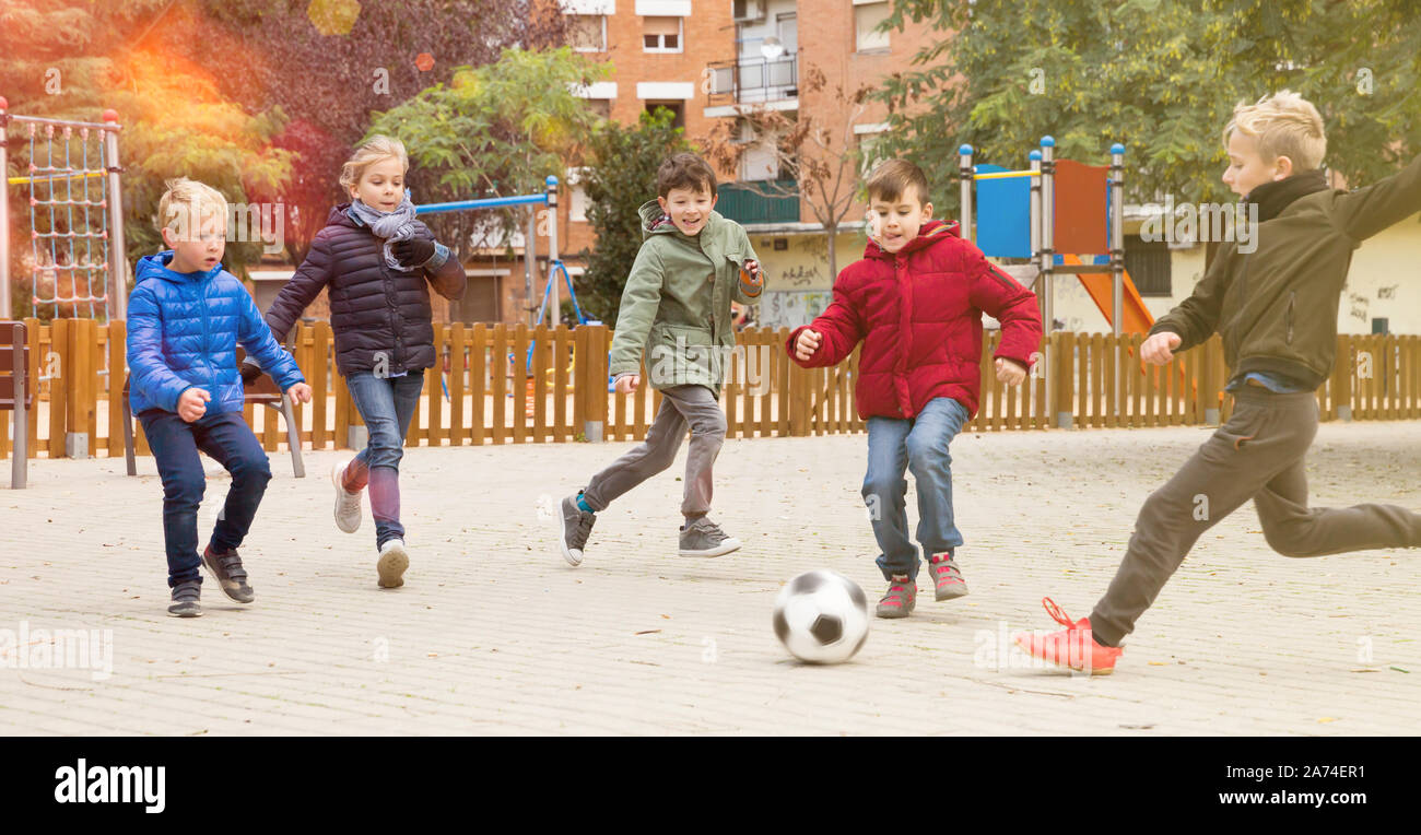 Group of laughing children playing football Stock Photo - Alamy