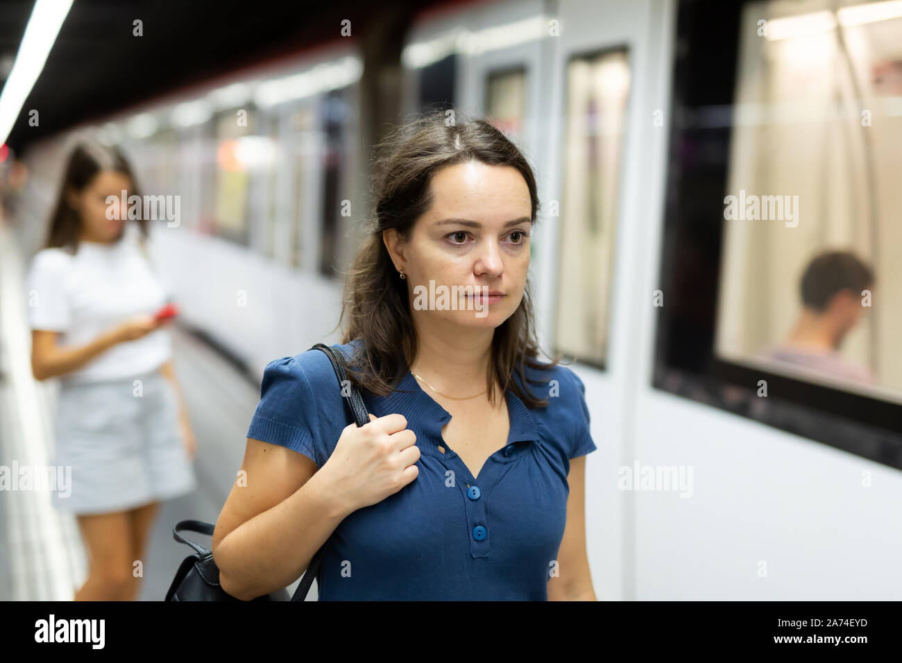 Pretty woman walks on the subway platform Stock Photo - Alamy