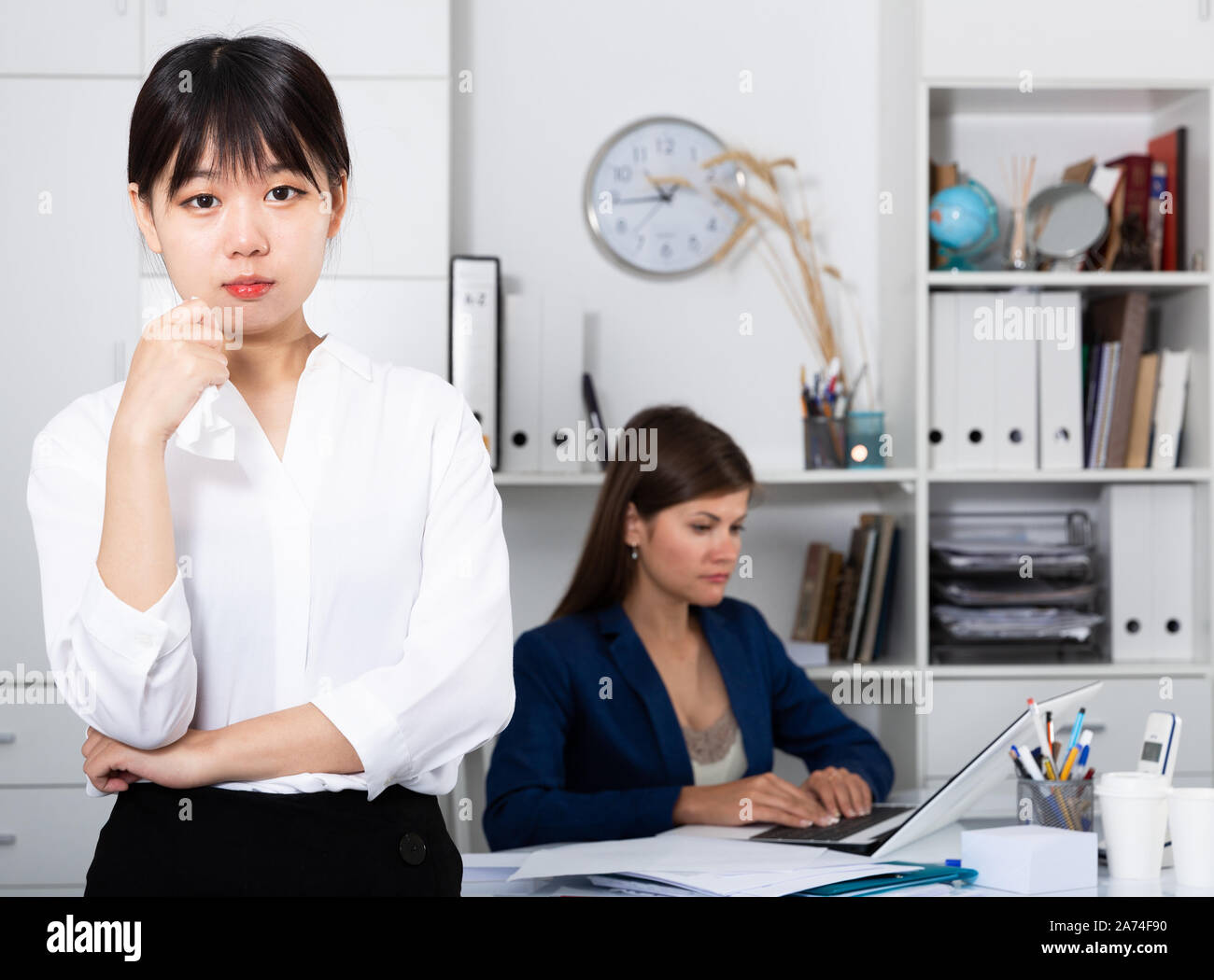 Boss dismissing an employee. Chinese woman crying in company office ...