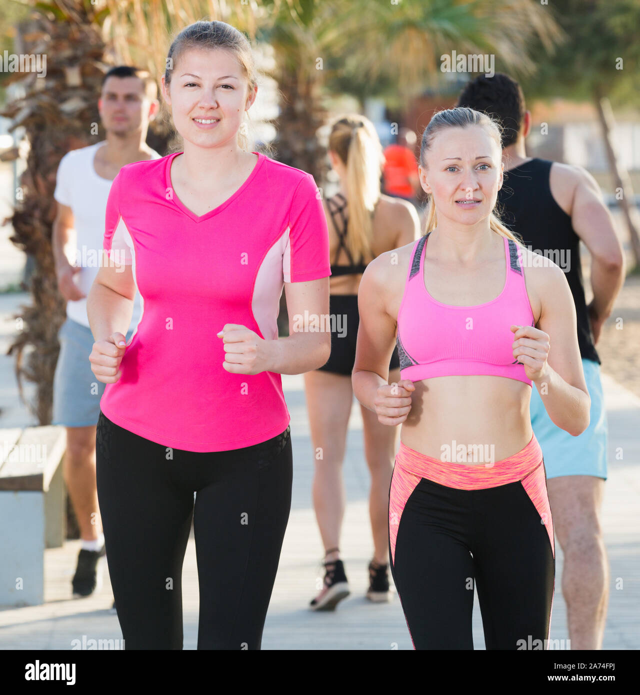 Active smiling people during running training in daytime Stock Photo ...