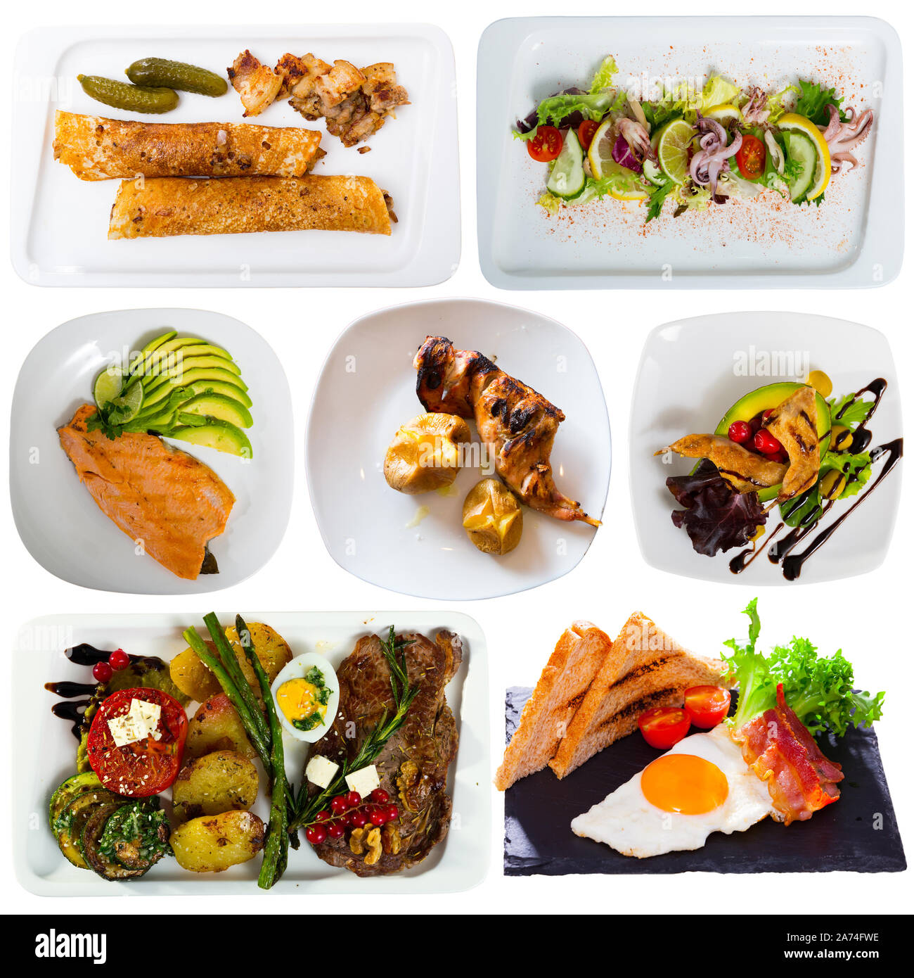 Set of various dishes served on plates, bowls and slates on white ...