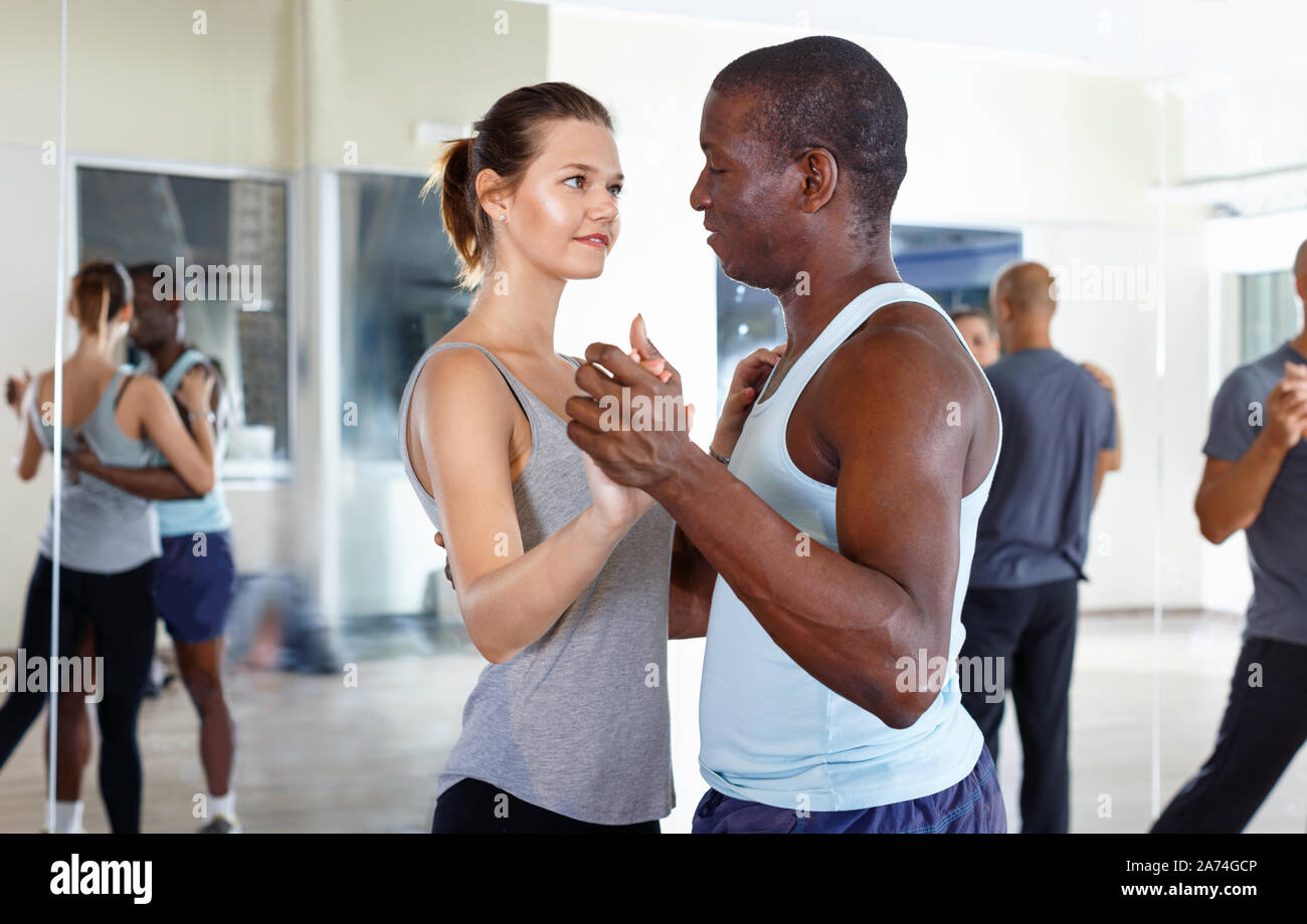 Young happy cheerful positive people dancing together slow ballroom ...