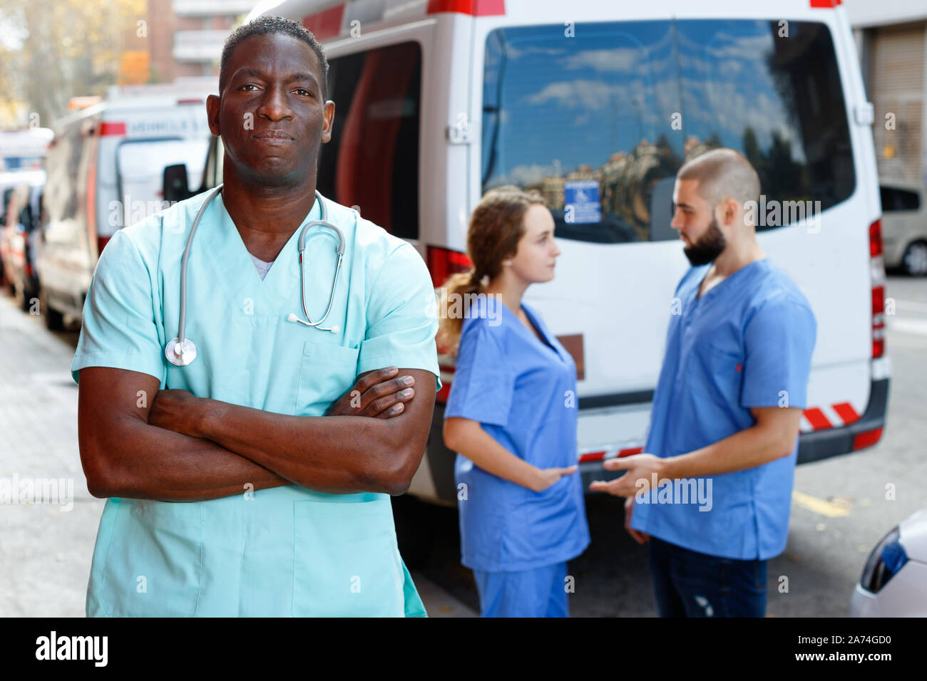 Portrait of efficient positive friendly ambulance paramedic standing ...