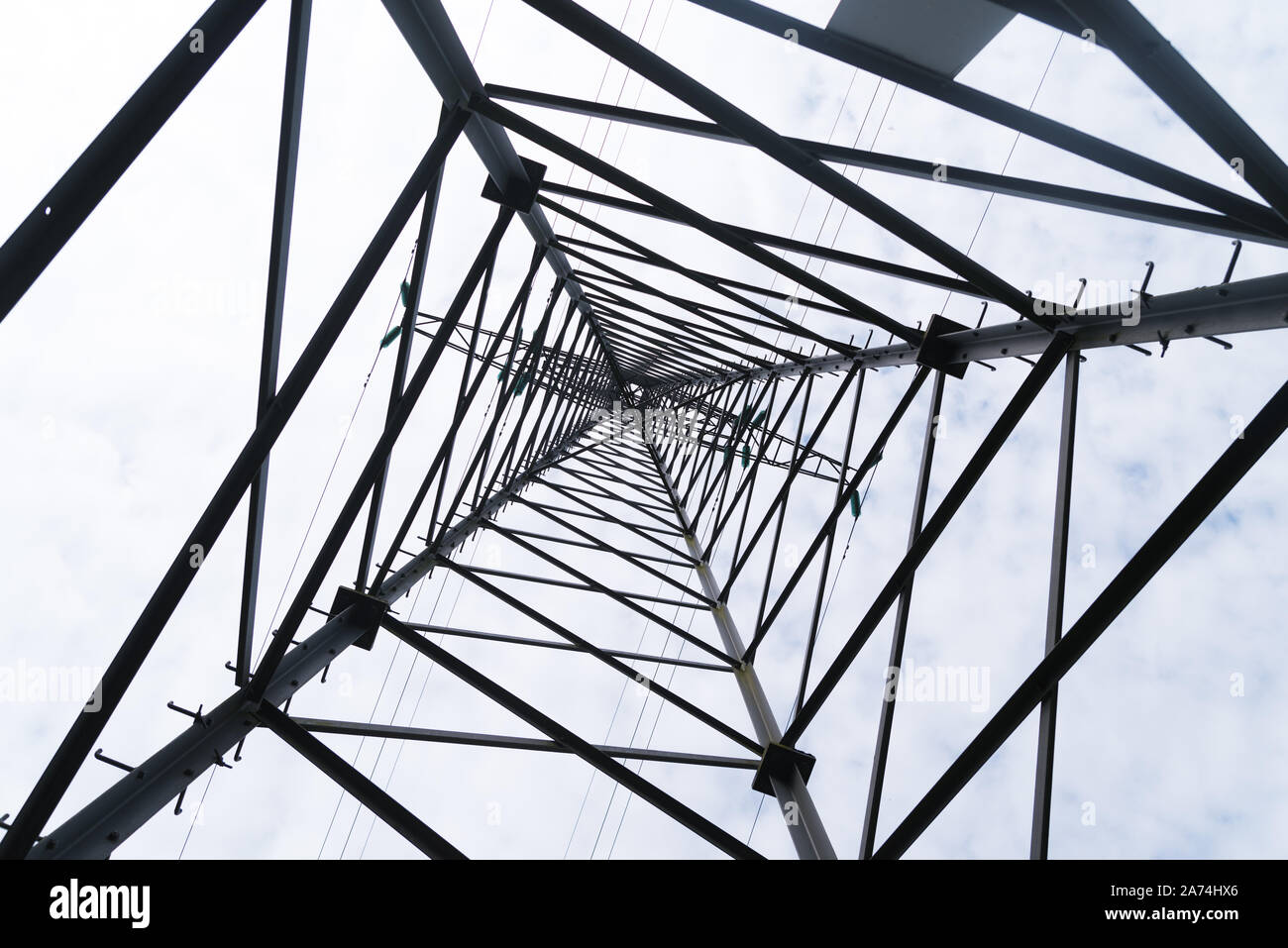 high voltage electricity pylon seen from below Stock Photo - Alamy