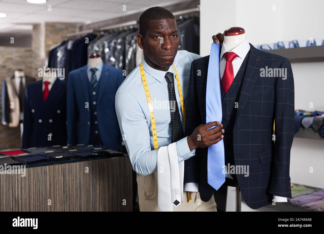 Portrait of afro-american man customer choosing business style tie in ...