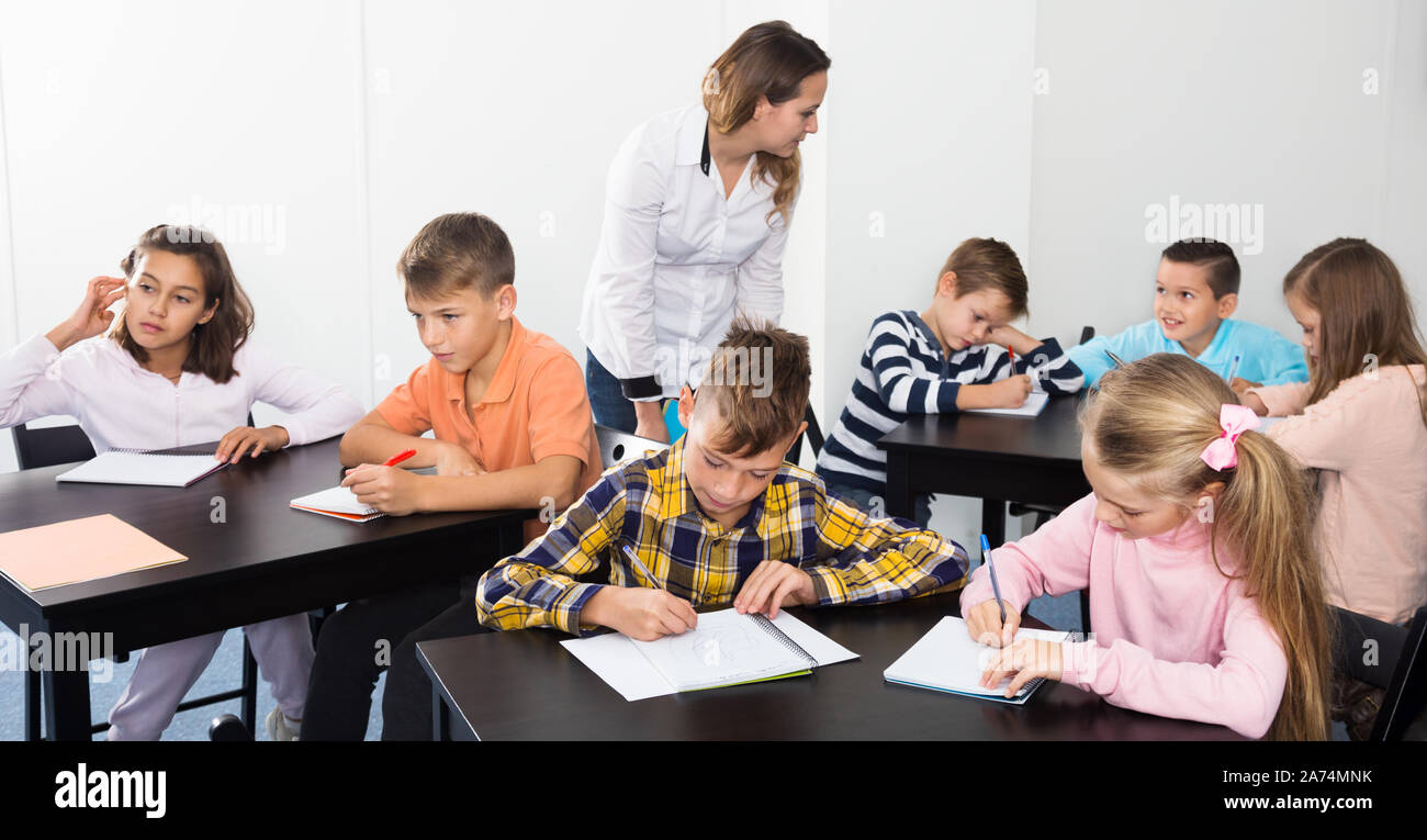 Little children with their teacher at classroom in school Stock Photo ...