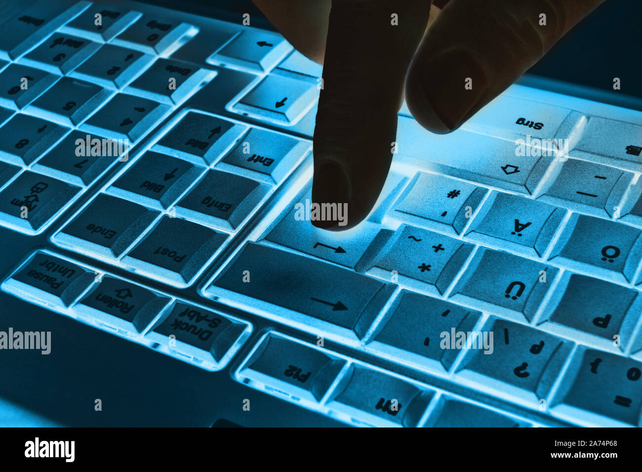 Keyboard close-up Enter key with finger Stock Photo - Alamy
