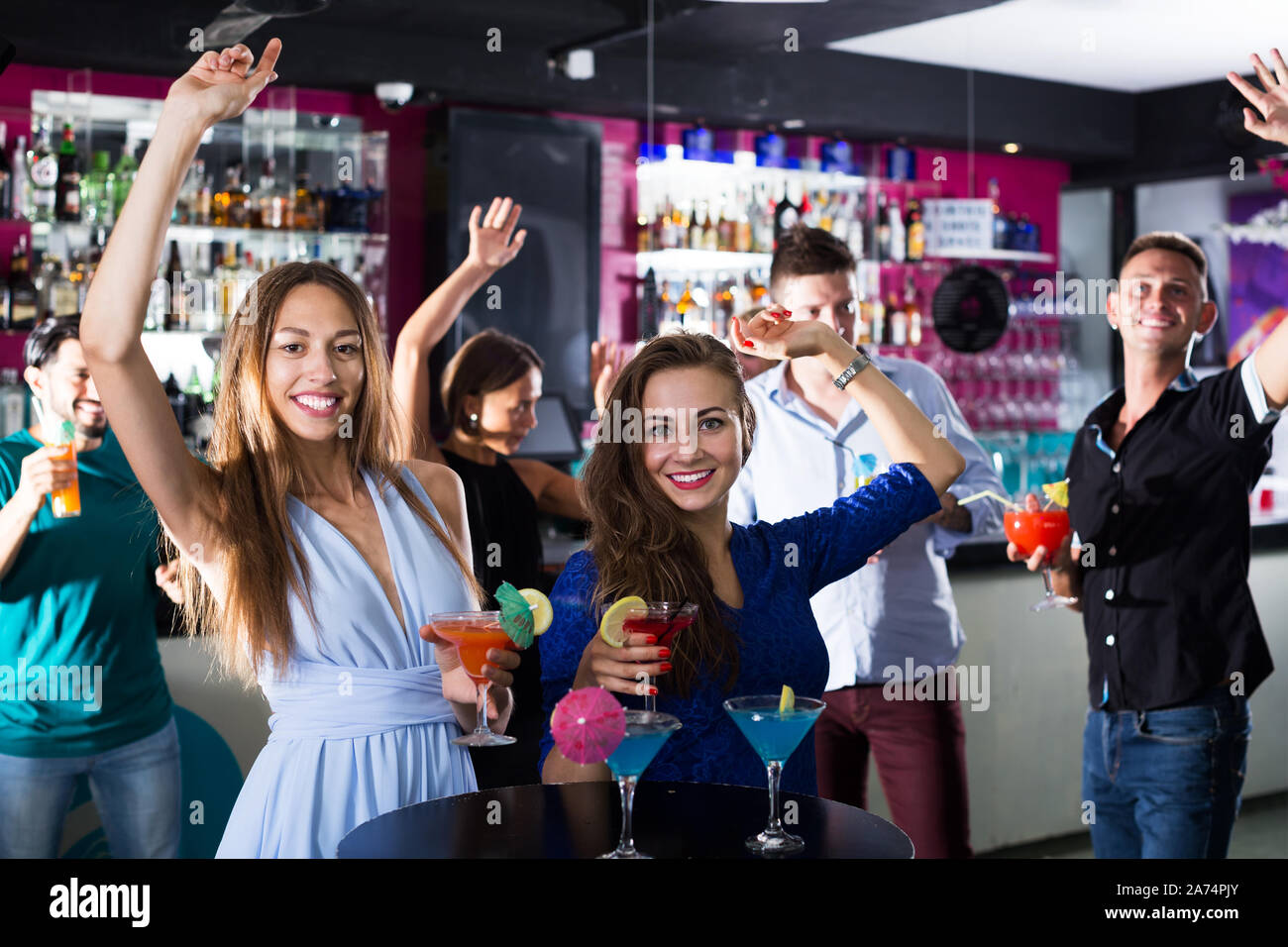 Two female are talking and drinking cocktails on the party Stock Photo ...