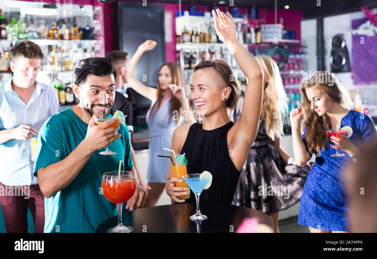 Young students dancing on party with the cocktails in a club Stock ...