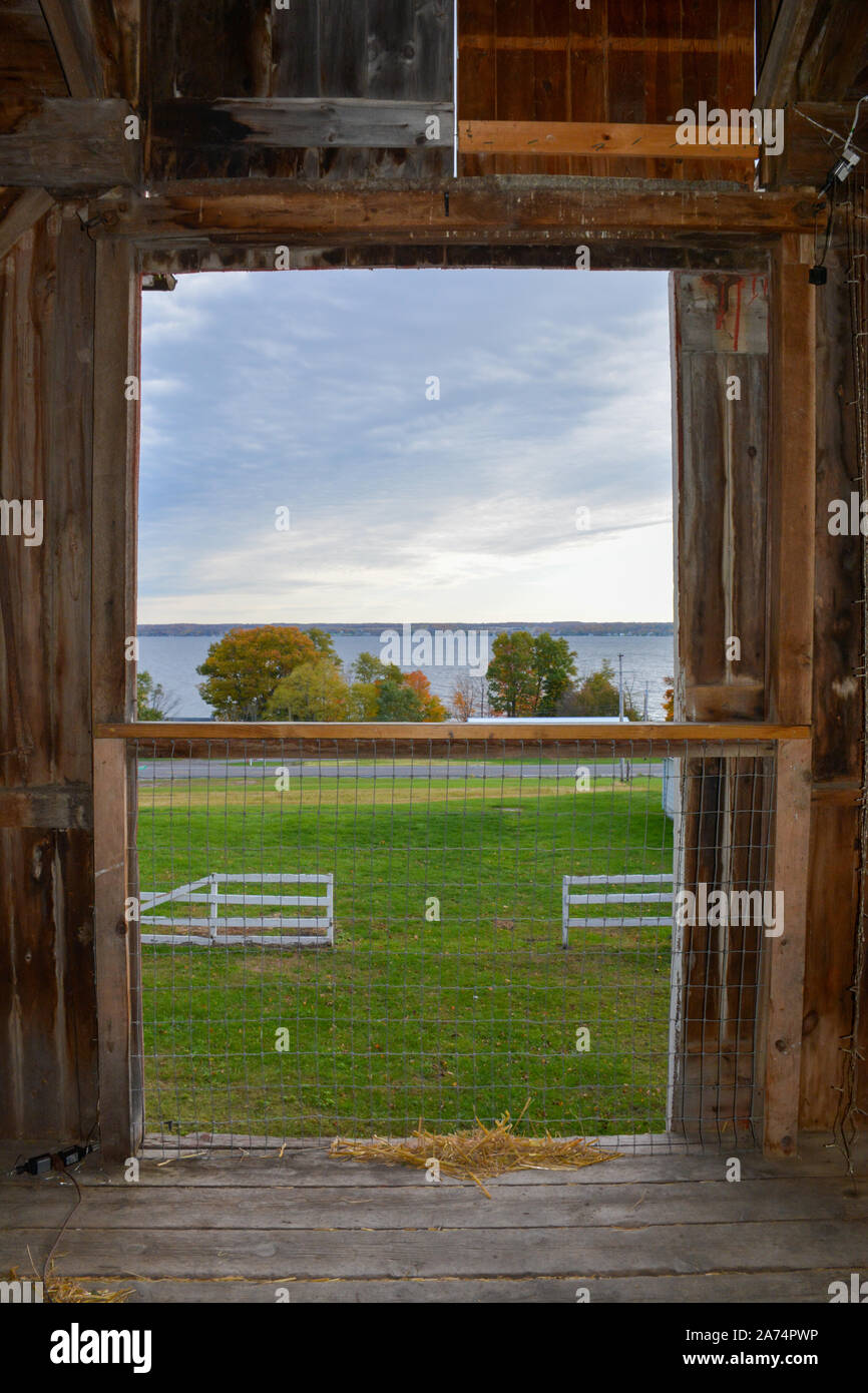 Rural autumn scene with lake through a barn door Stock Photo - Alamy