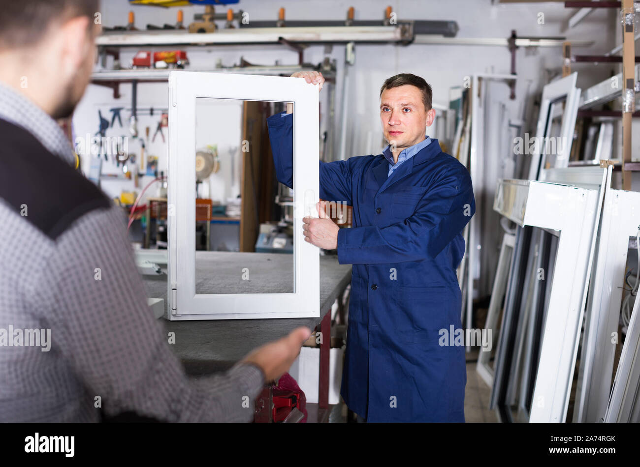 Production happy spanish worker in coverall demonstrating different PVC ...