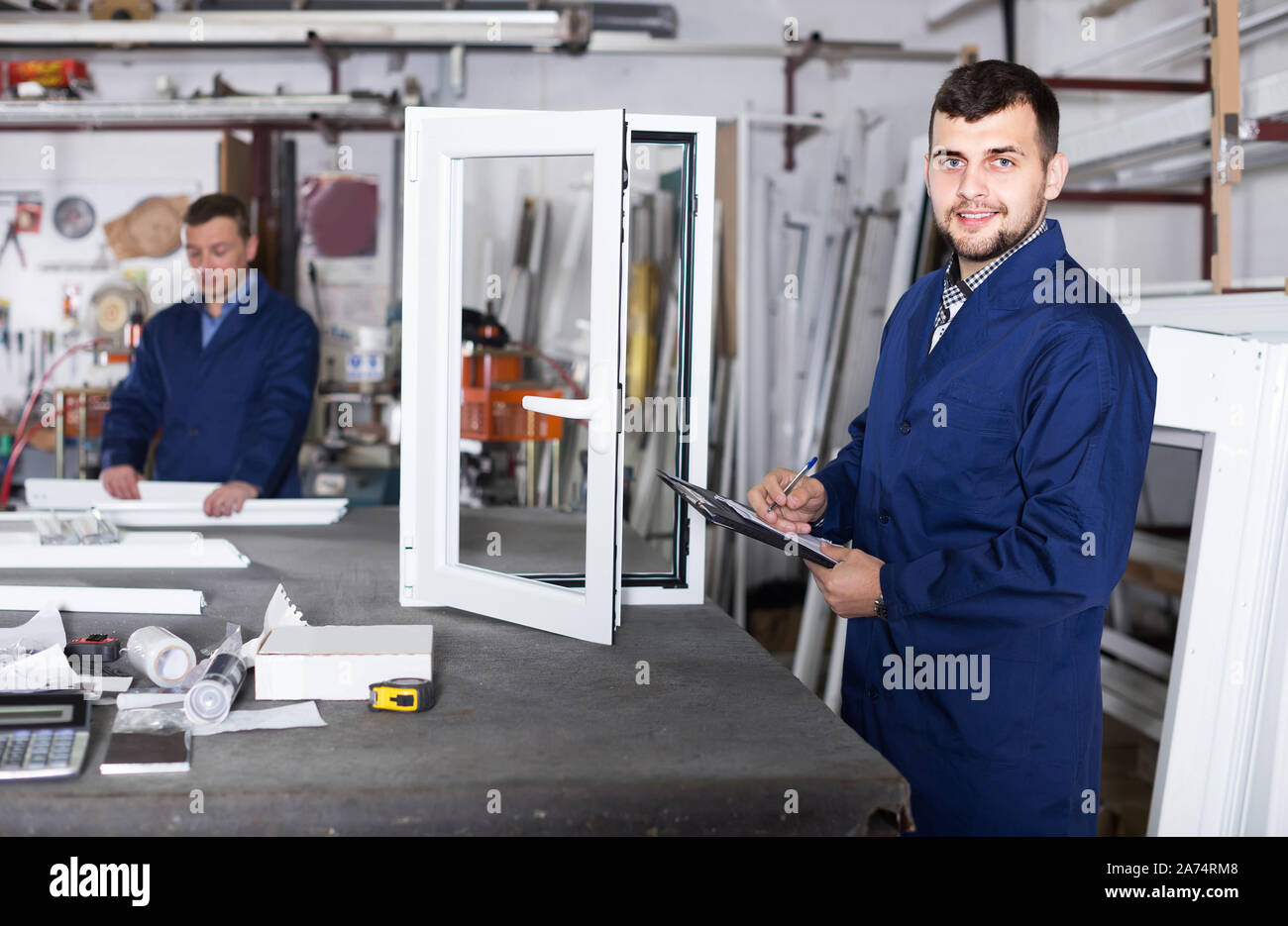 happy worker doing inspection and checking papers Stock Photo - Alamy