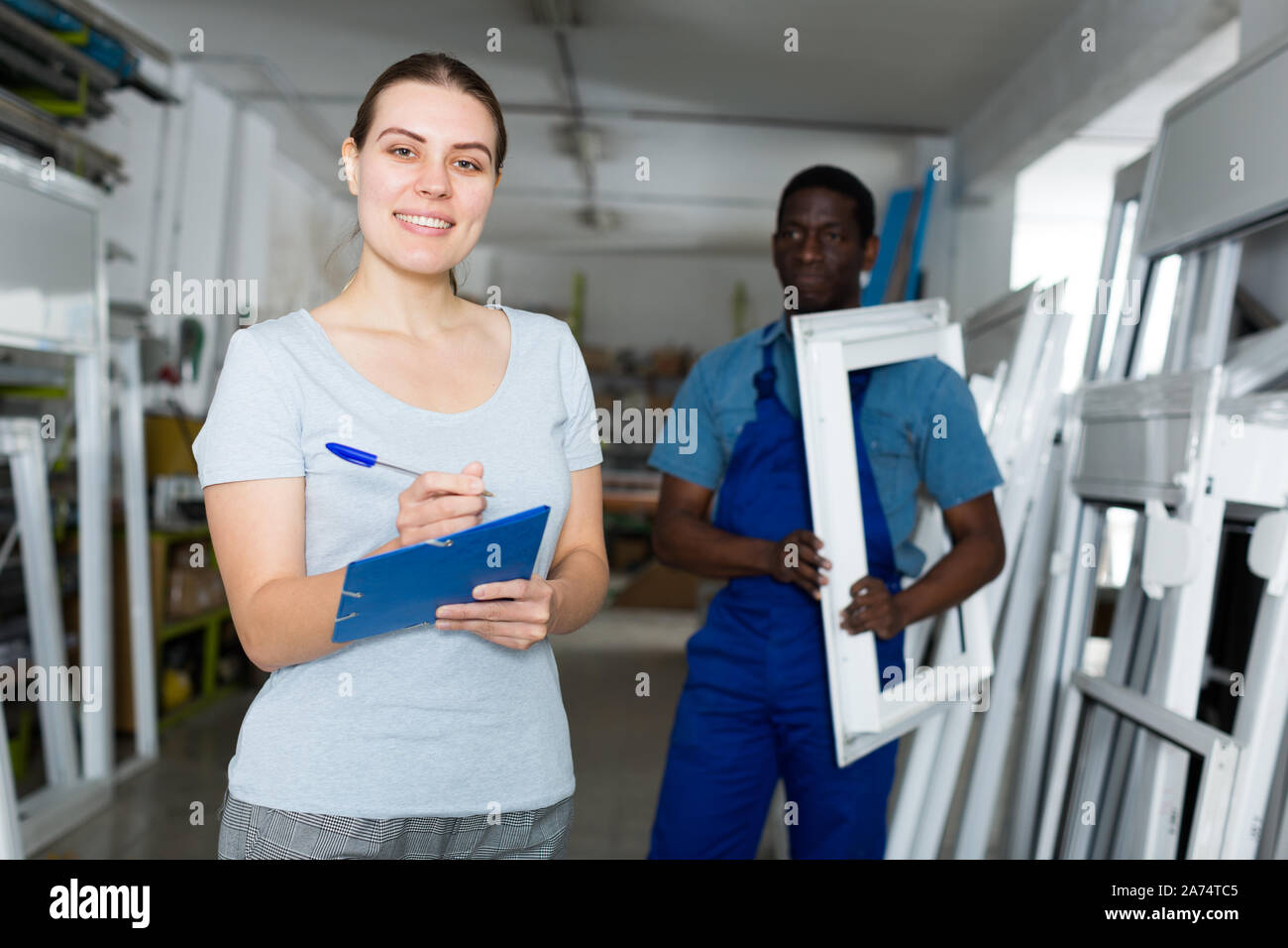 Female client is signing documents after choosing modern window for her ...