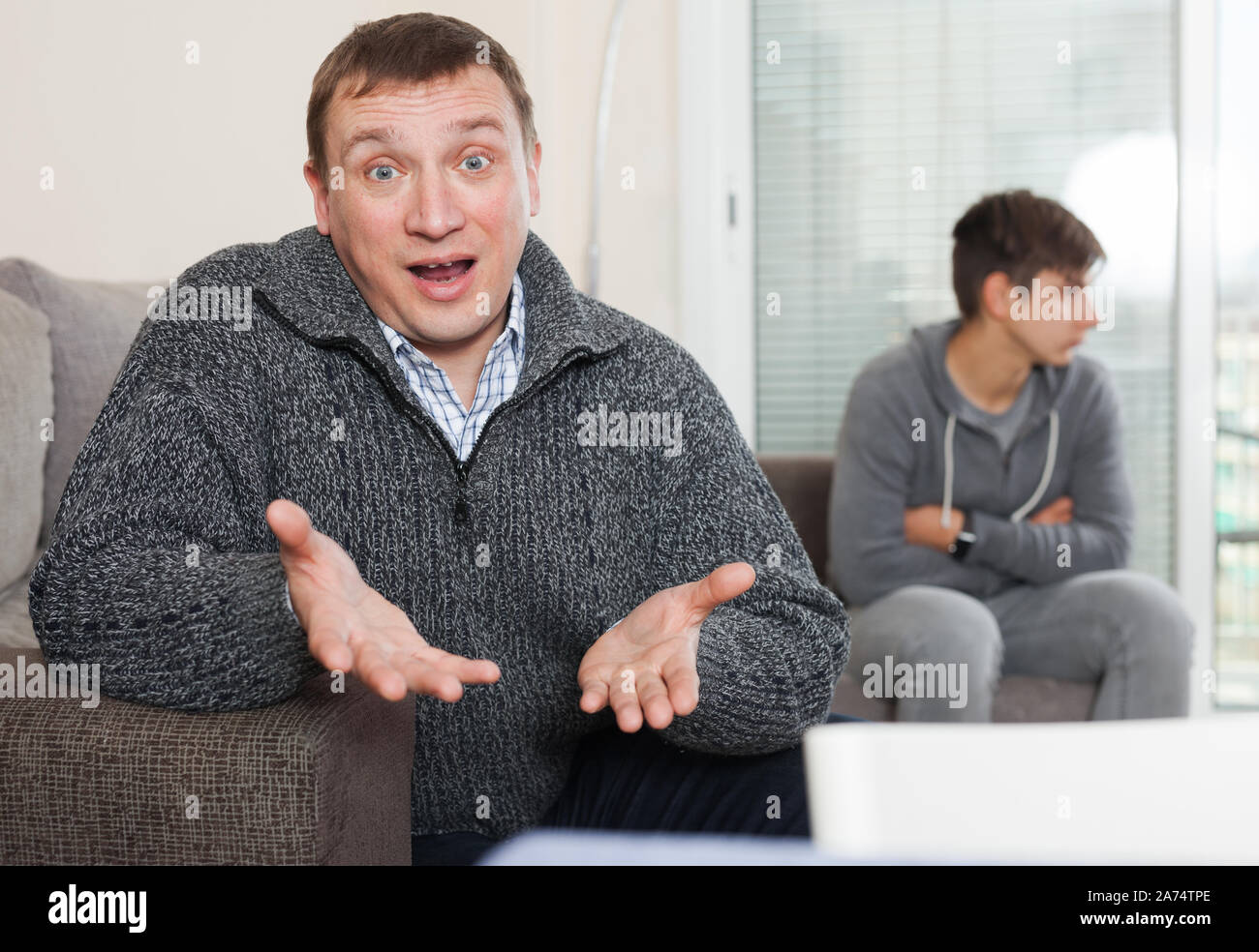 Outraged father unhappy with his son teenager Stock Photo - Alamy