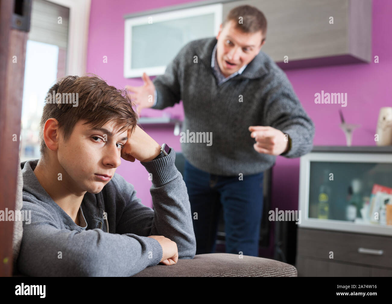Dissatisfied father scolds young son Stock Photo - Alamy