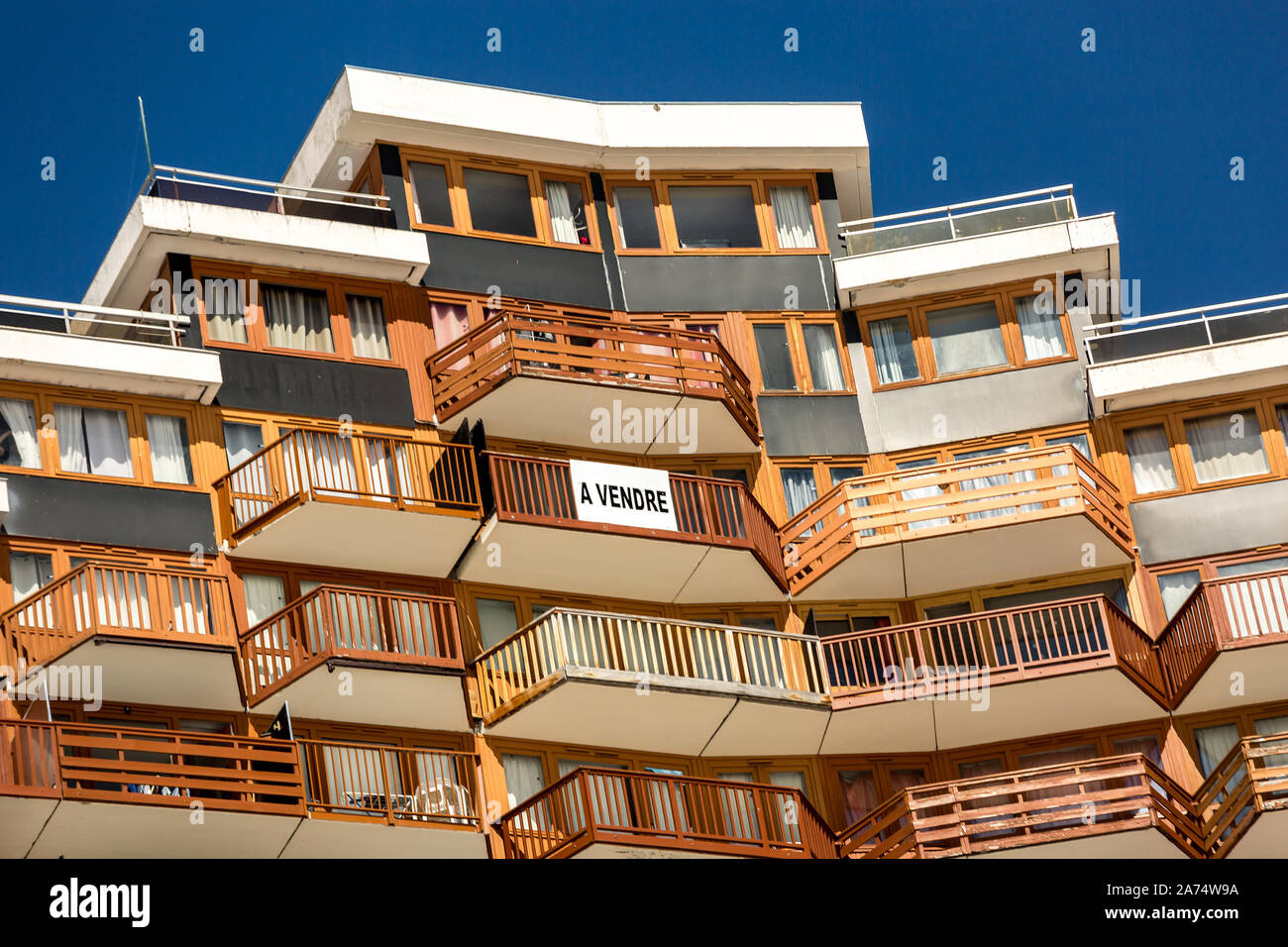 From below pyramid shaped apartment building with many balconies ...