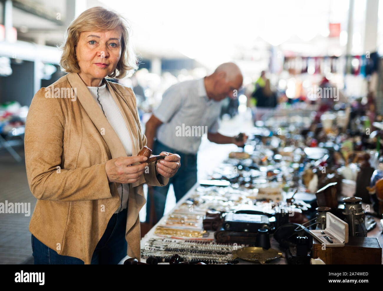 Mature couple choose smoking pipe on flea market Stock Photo - Alamy