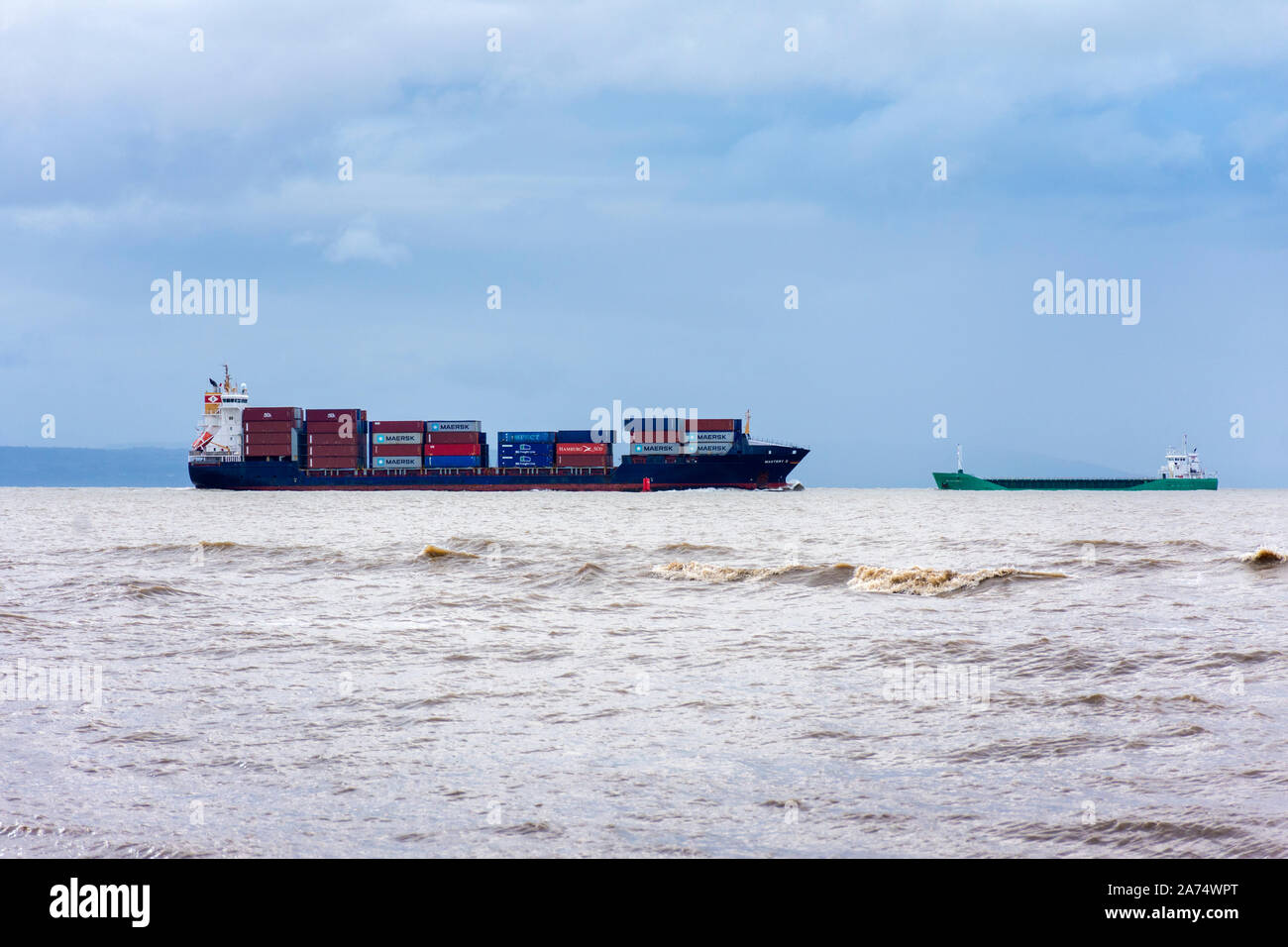 River Mersey, Liverpool, UK. A container ship departs the docks as ...