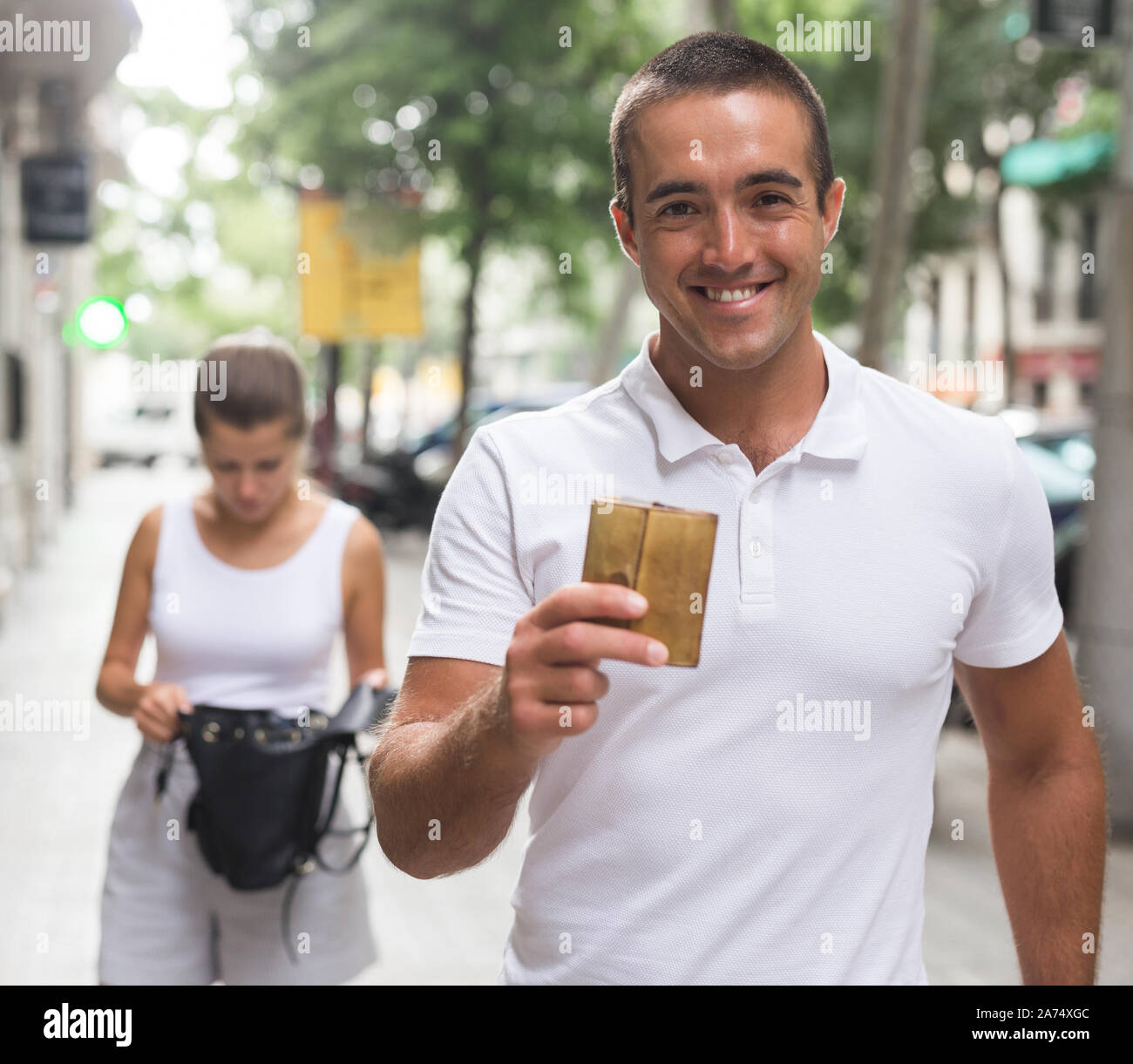 Male thief stealing girl purse on street Stock Photo - Alamy