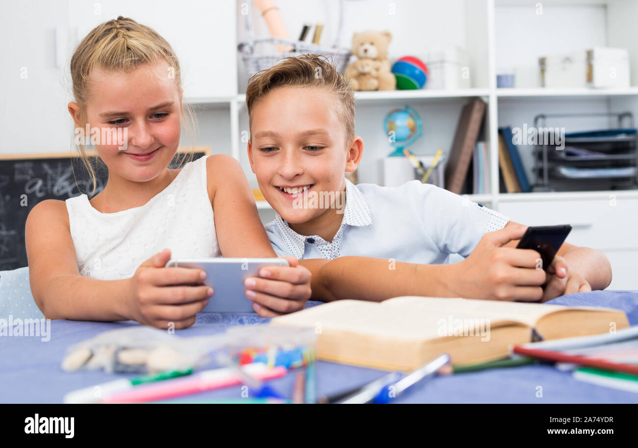 Children are playing in smartphones at home Stock Photo - Alamy