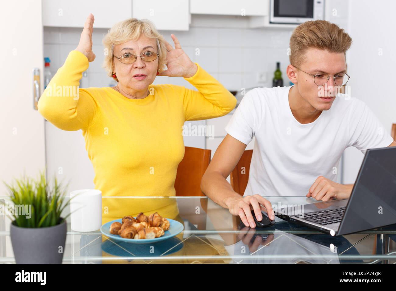 Senior mother lecturing her sad adult son at kitchen Stock Photo - Alamy