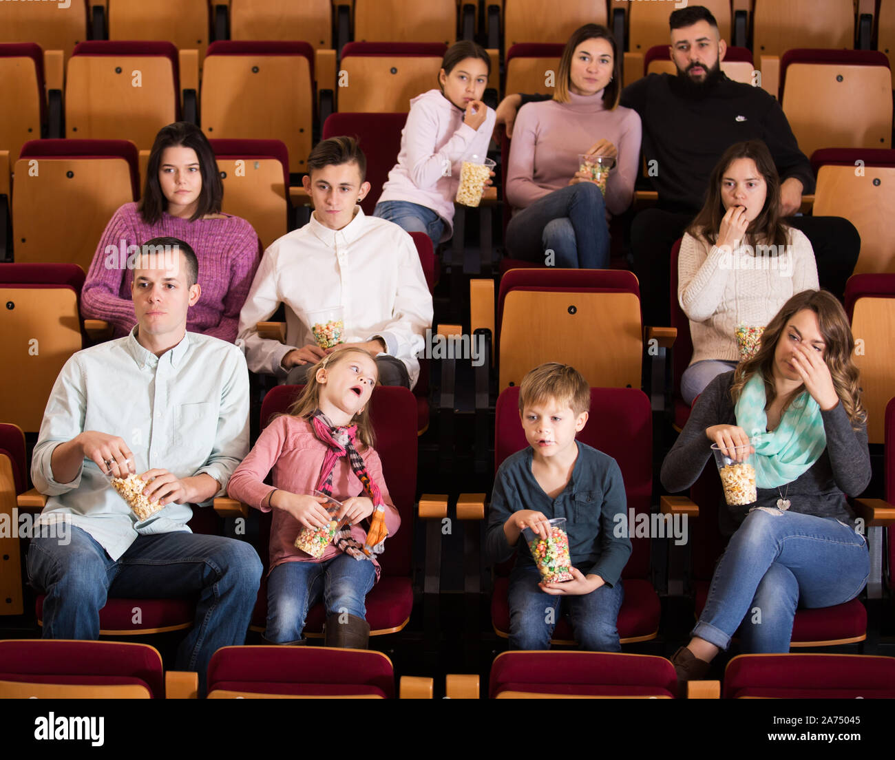 Group of people eating popcorn during film in cinema interior Stock ...