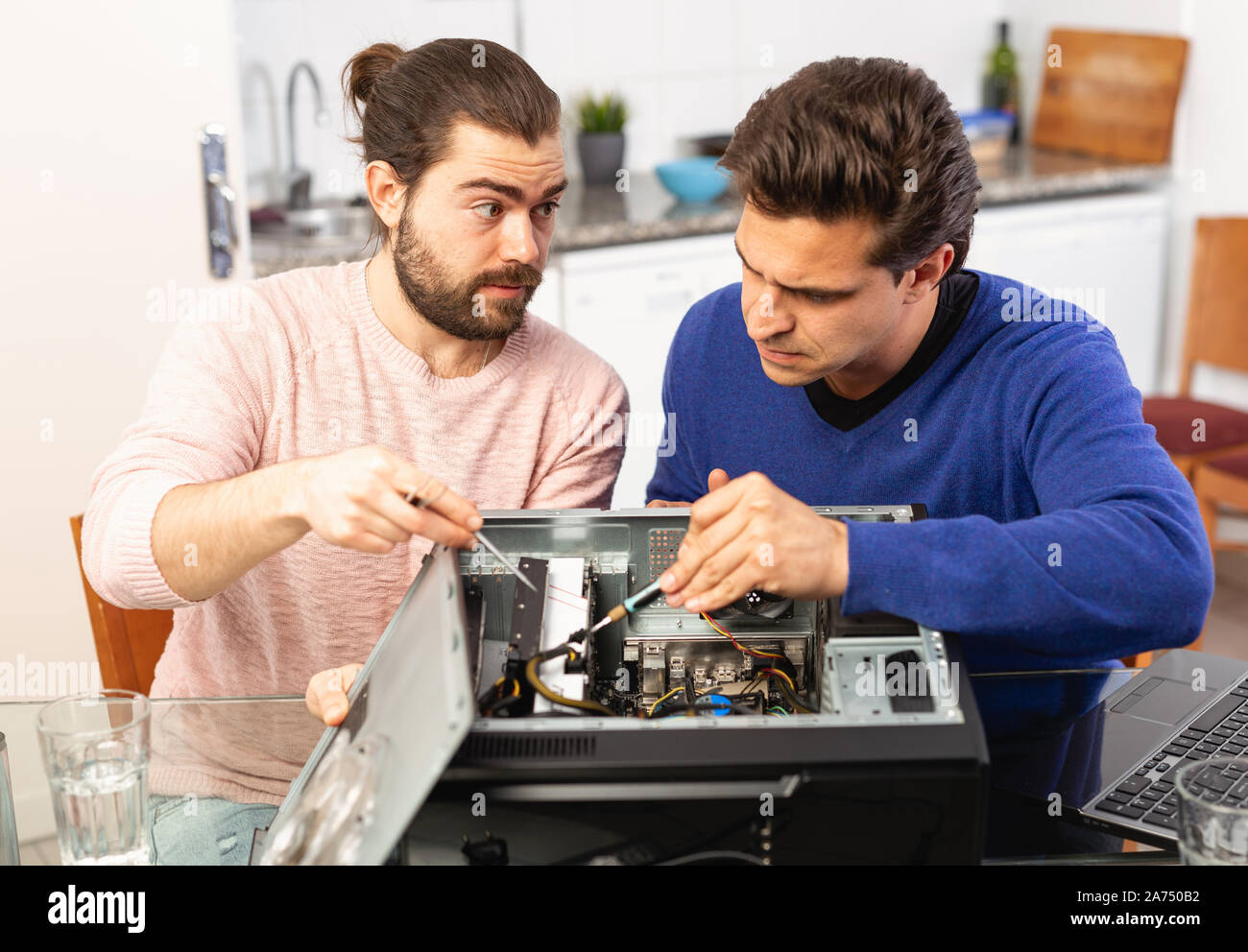 Two men are engaged in assembling a desktop computer Stock Photo - Alamy