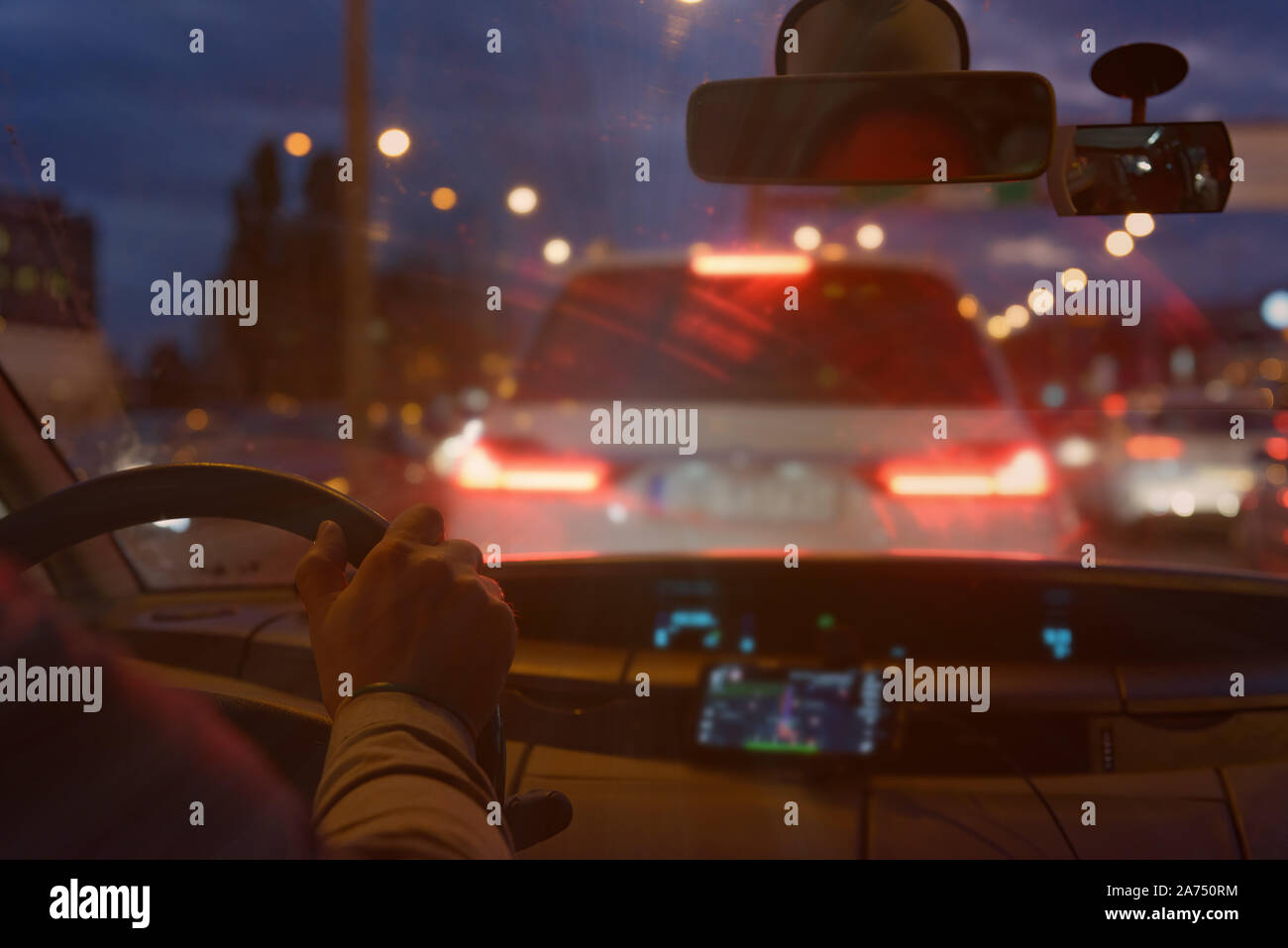Driving a car in the city at night in traffic jams. the concept of a ...