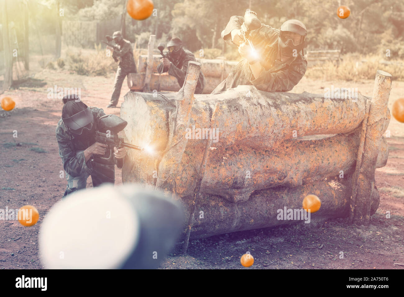 Portrait of man and woman paintball players in full gear playing ...