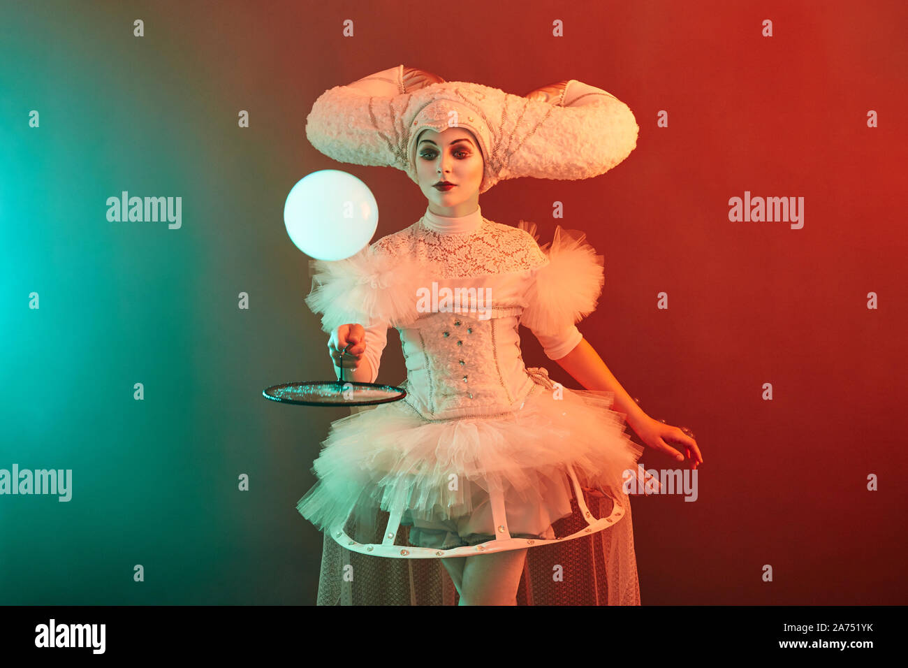 Circus performer magician shows tricks with soap bubbles. A woman and a ...