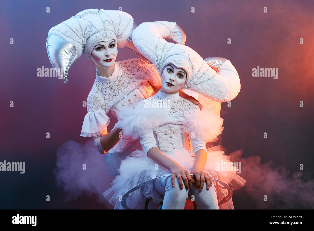 Circus performer magician shows tricks with soap bubbles. A woman and a ...